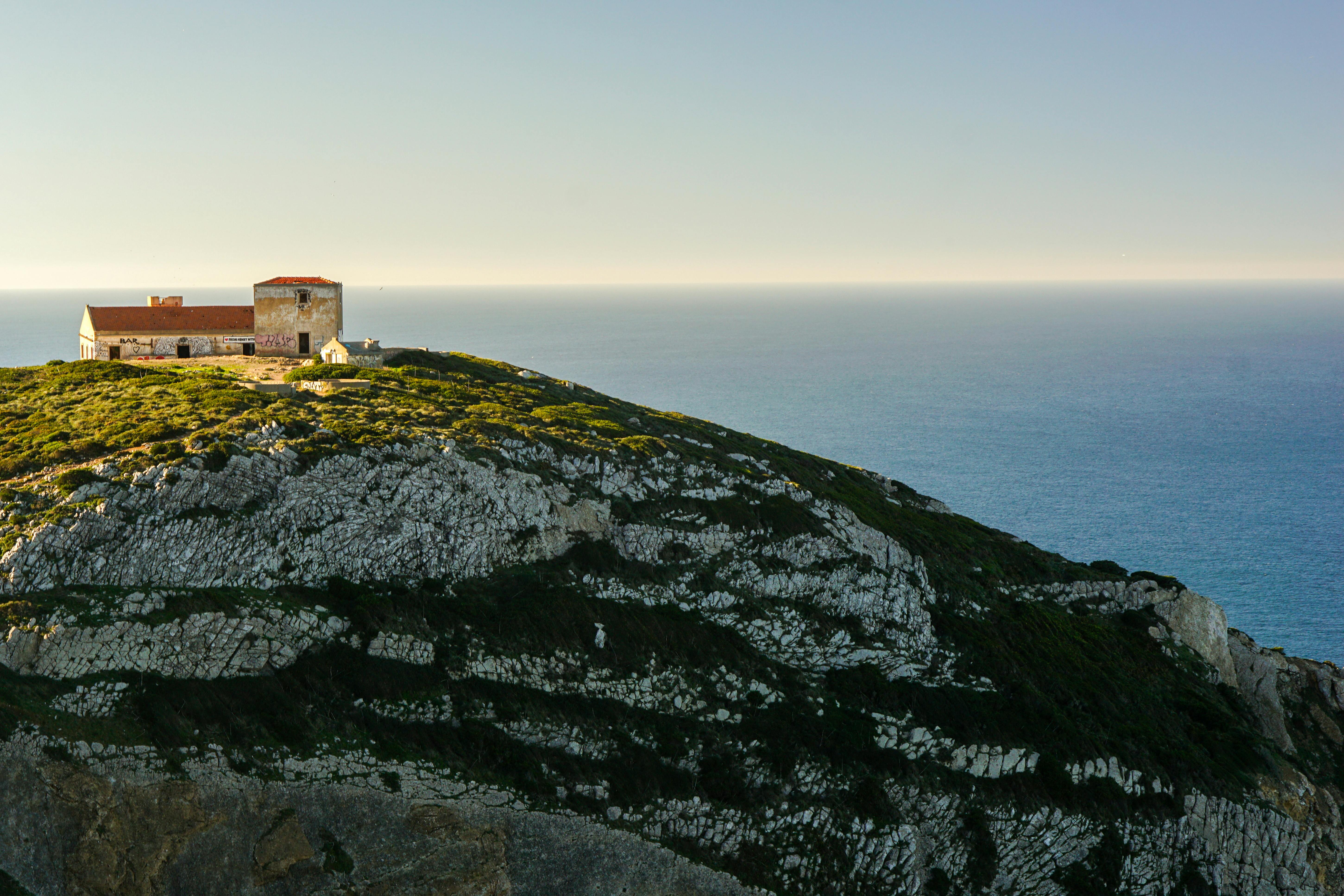 Building on Hill Overlooking Sea · Free Stock Photo