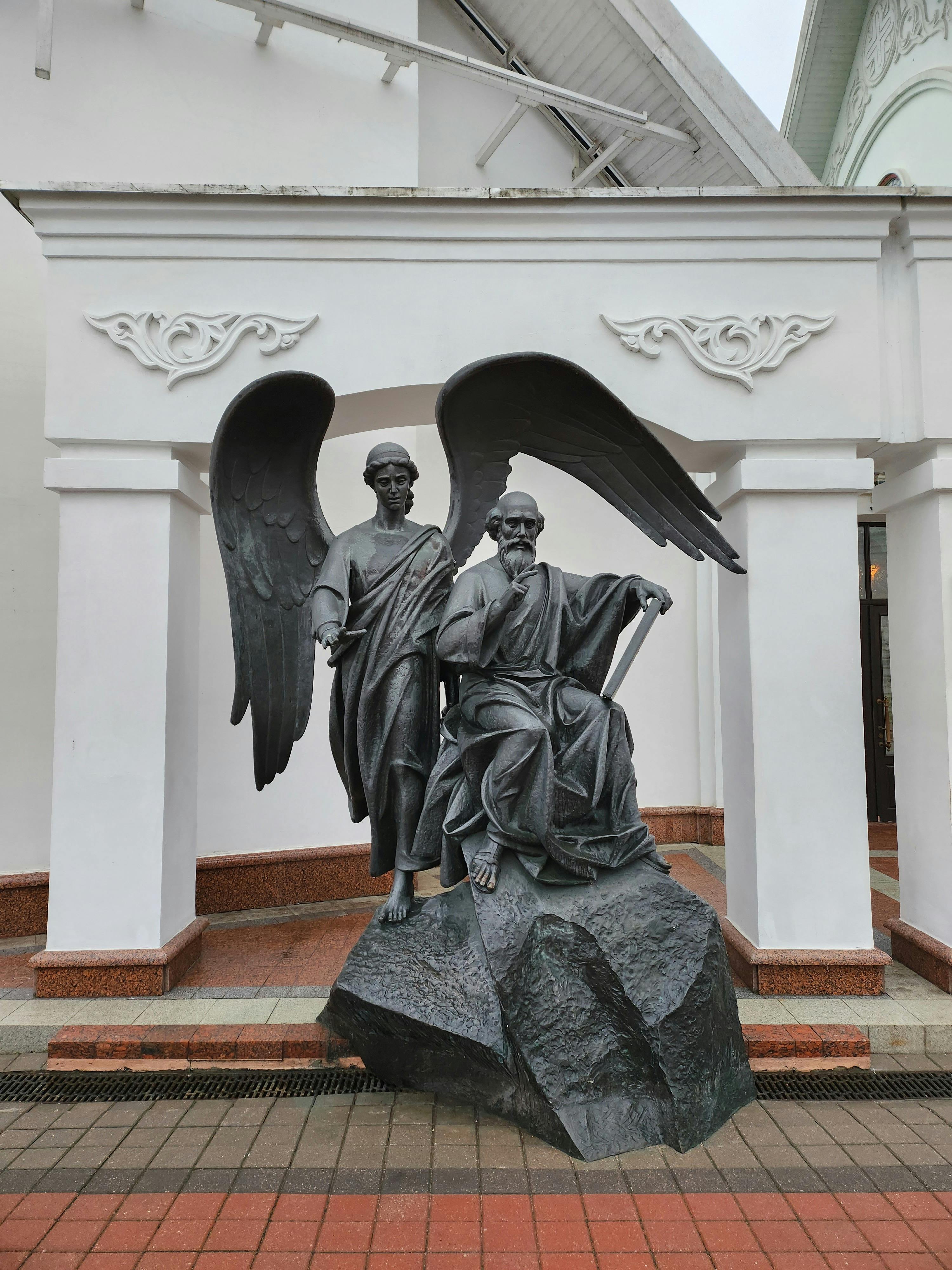 Statue near Building Wall · Free Stock Photo