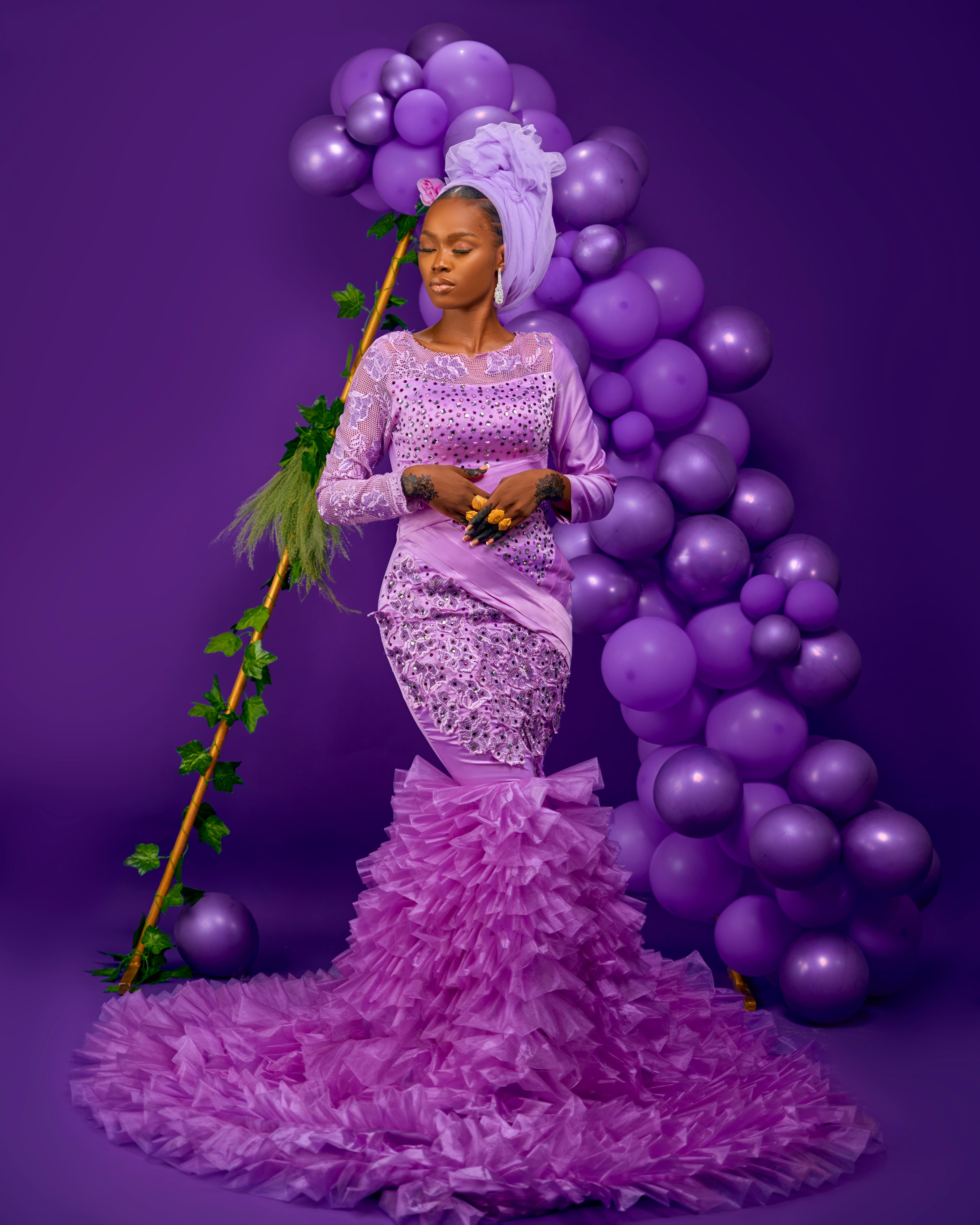 Model in Long Purple Dress Posing by Balloons in Studio · Free Stock Photo
