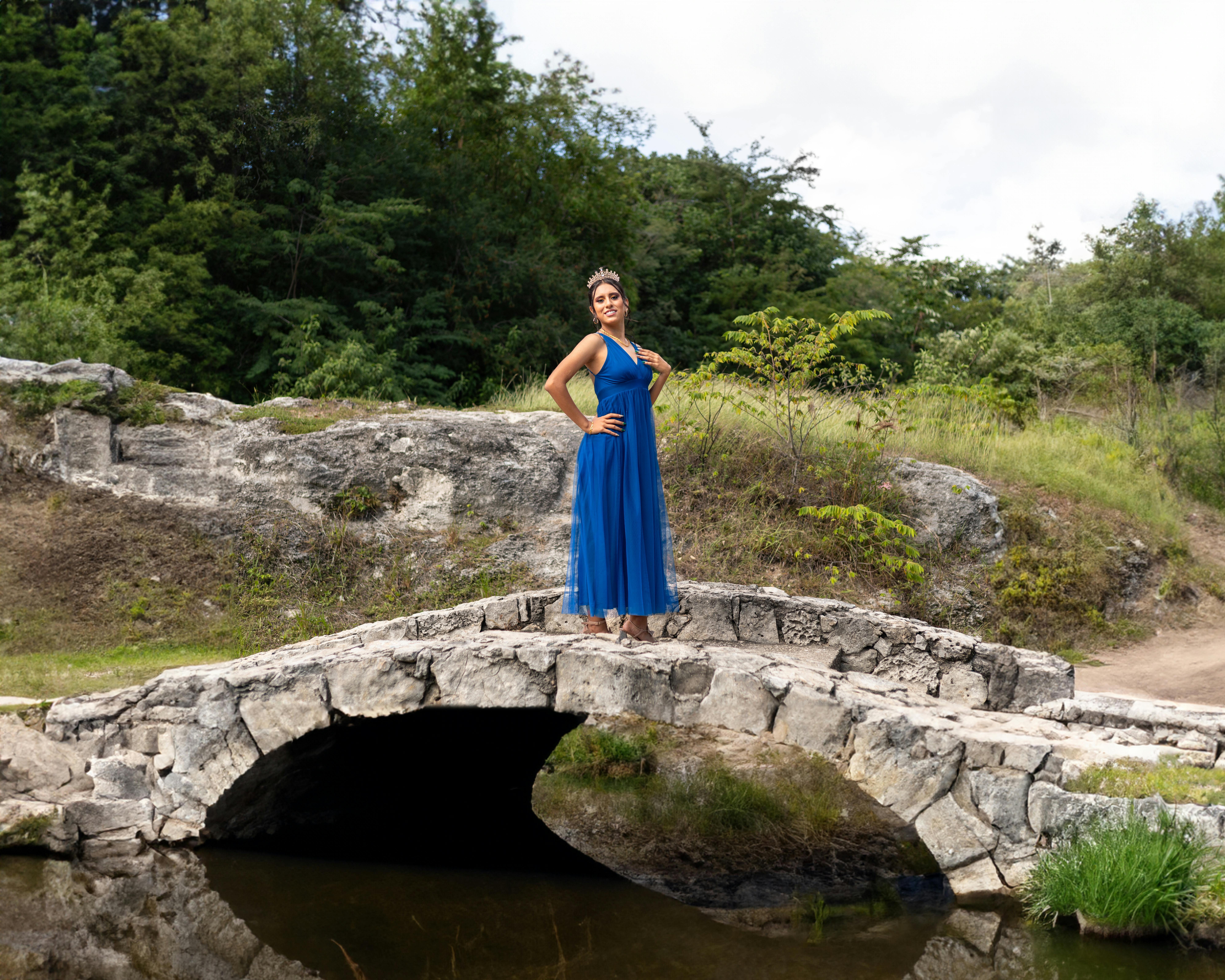 Woman in Blue Dress and Crown Standing on Stone Footbridge · Free Stock ...