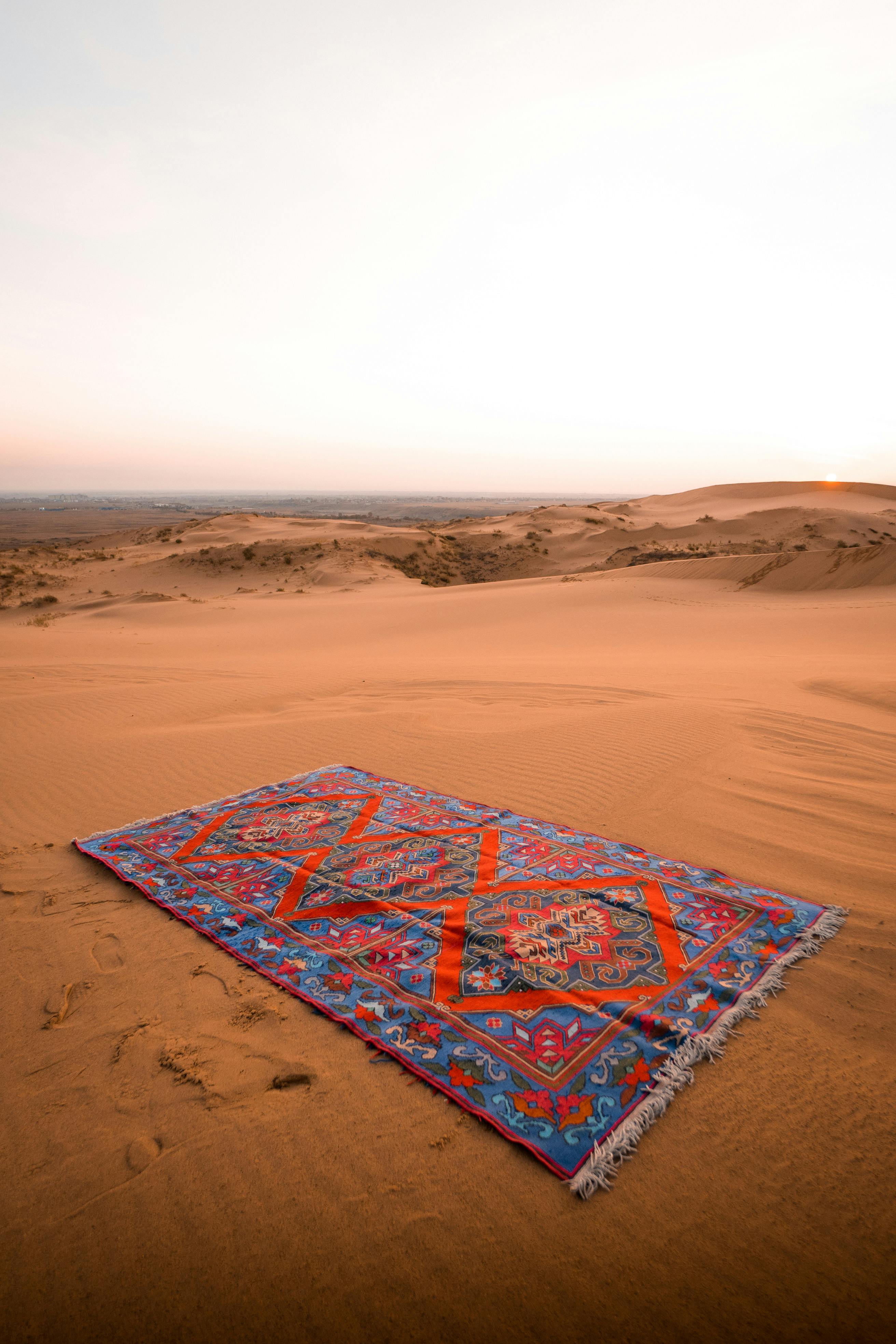 A Rug with an Oriental Pattern Lying on the Ground in the Desert · Free ...