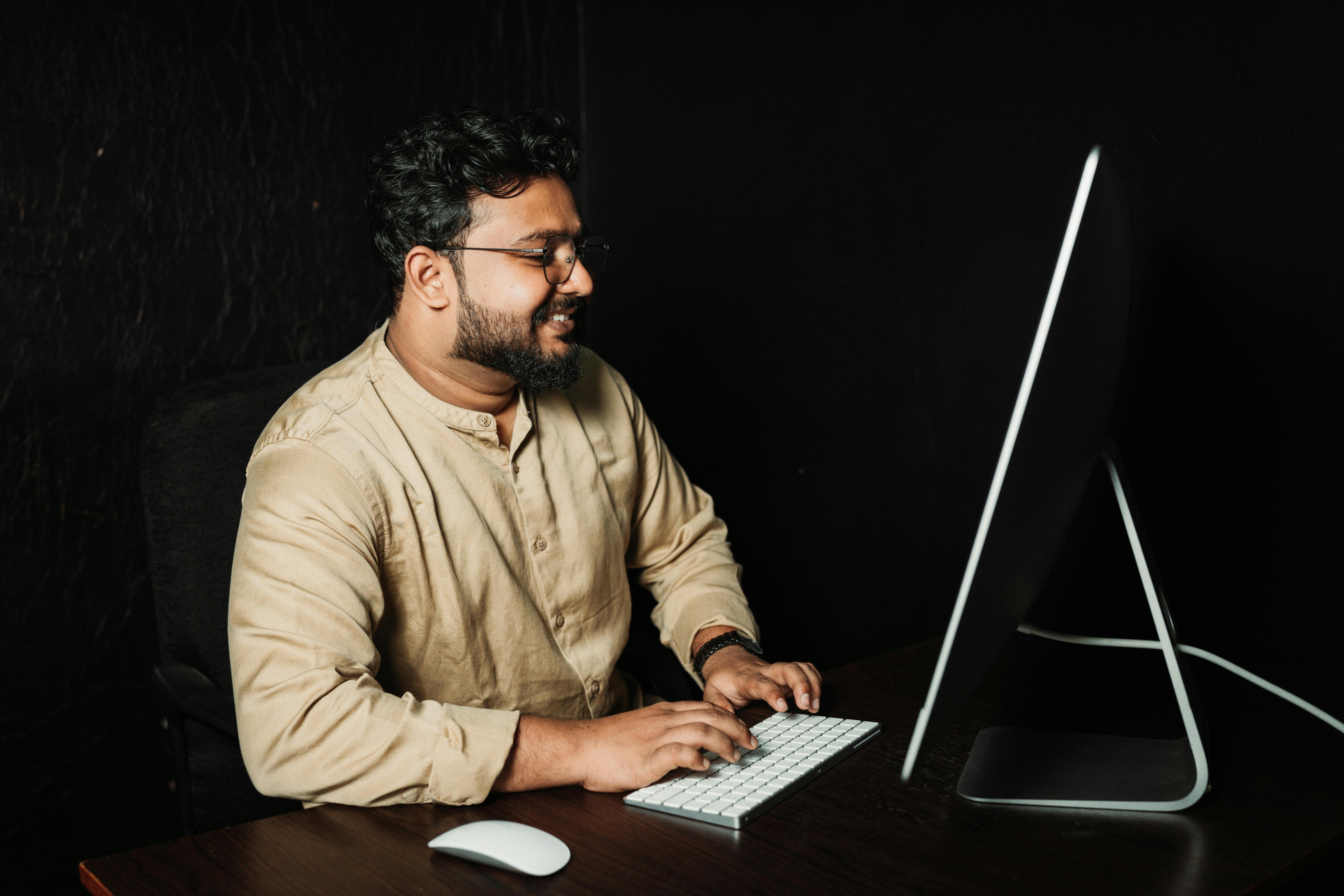 Man Working on a Computer · Free Stock Photo