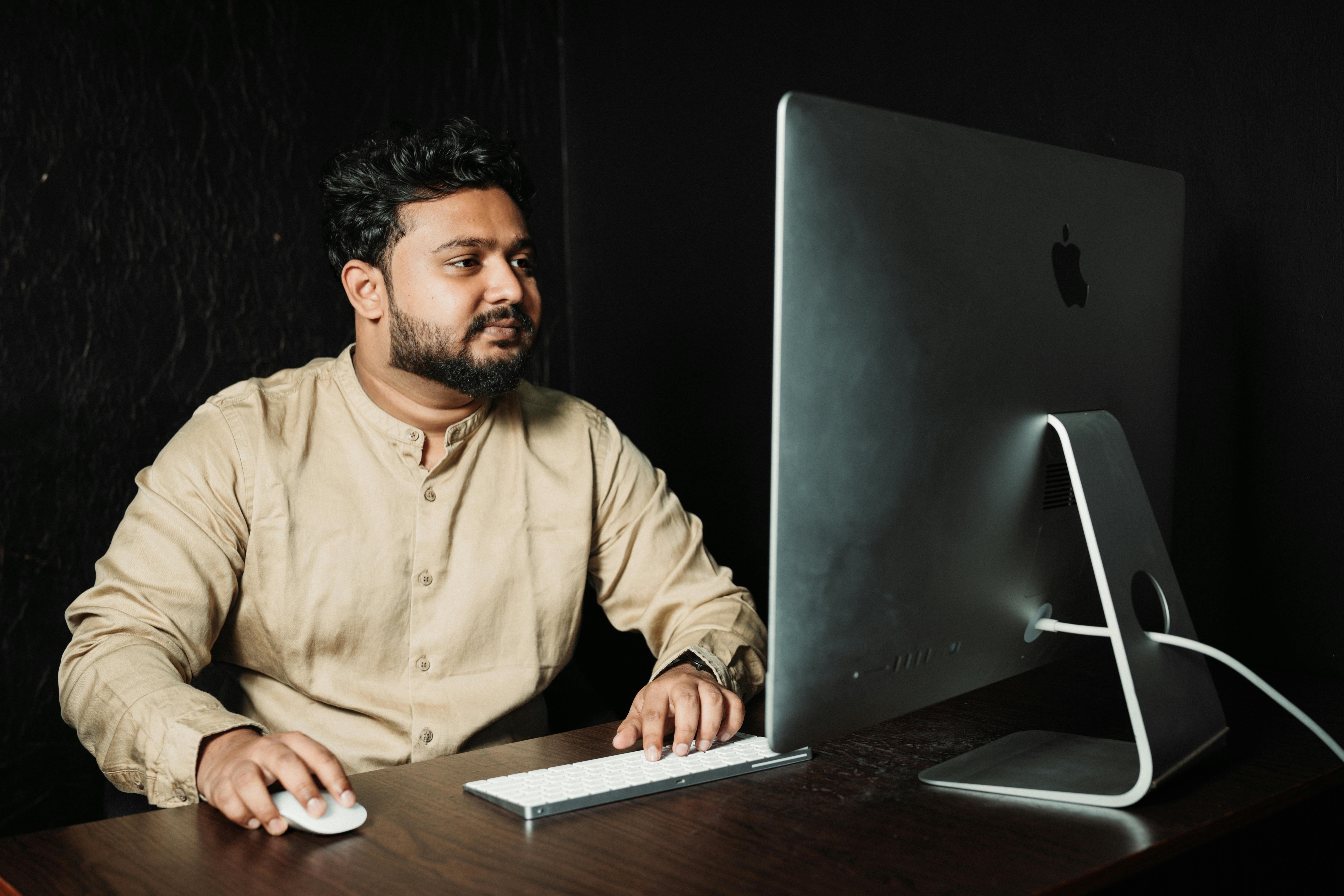 Man Working on a Computer · Free Stock Photo