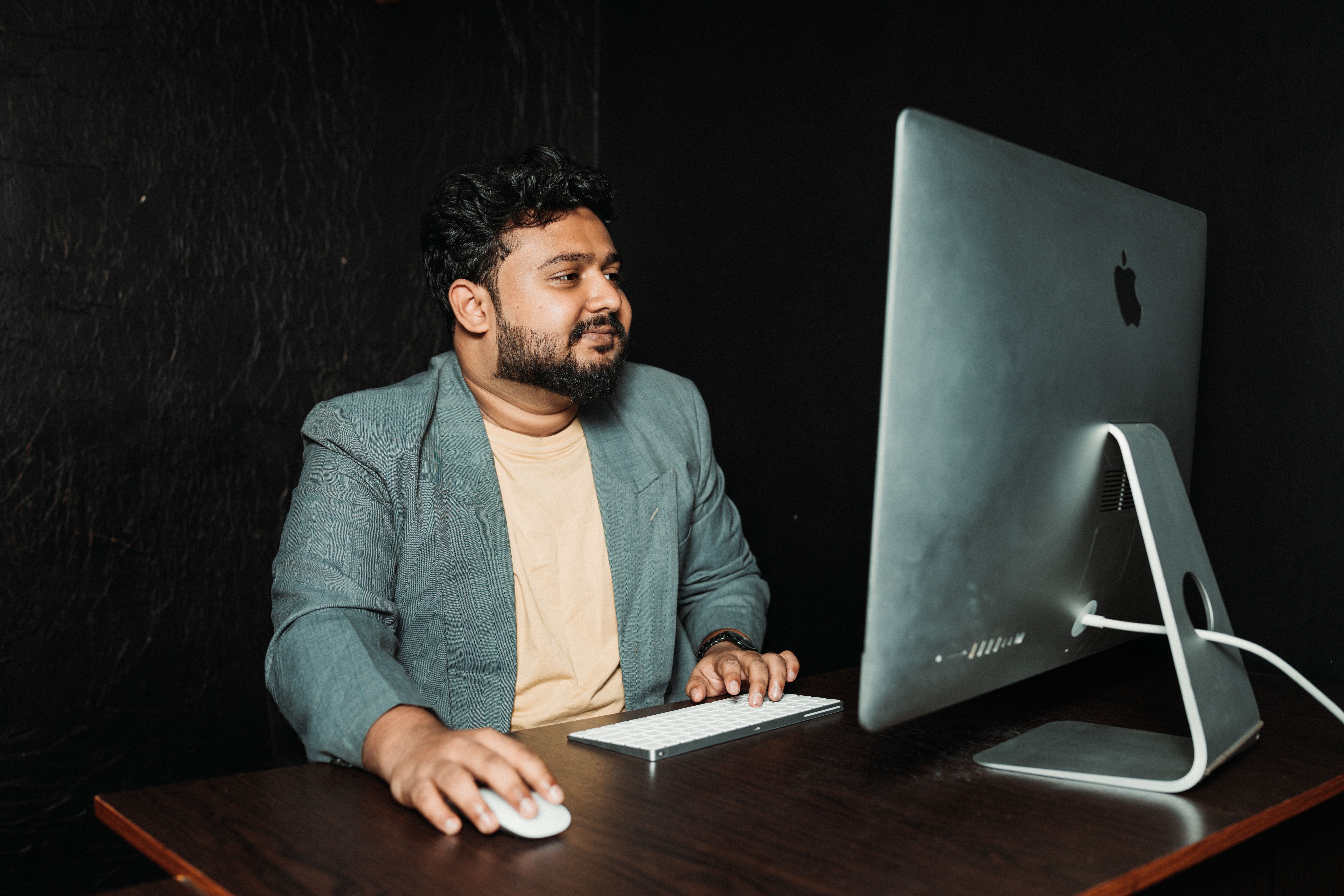 Man Working with Wireless Keyboard and Mouse in Office · Free Stock Photo