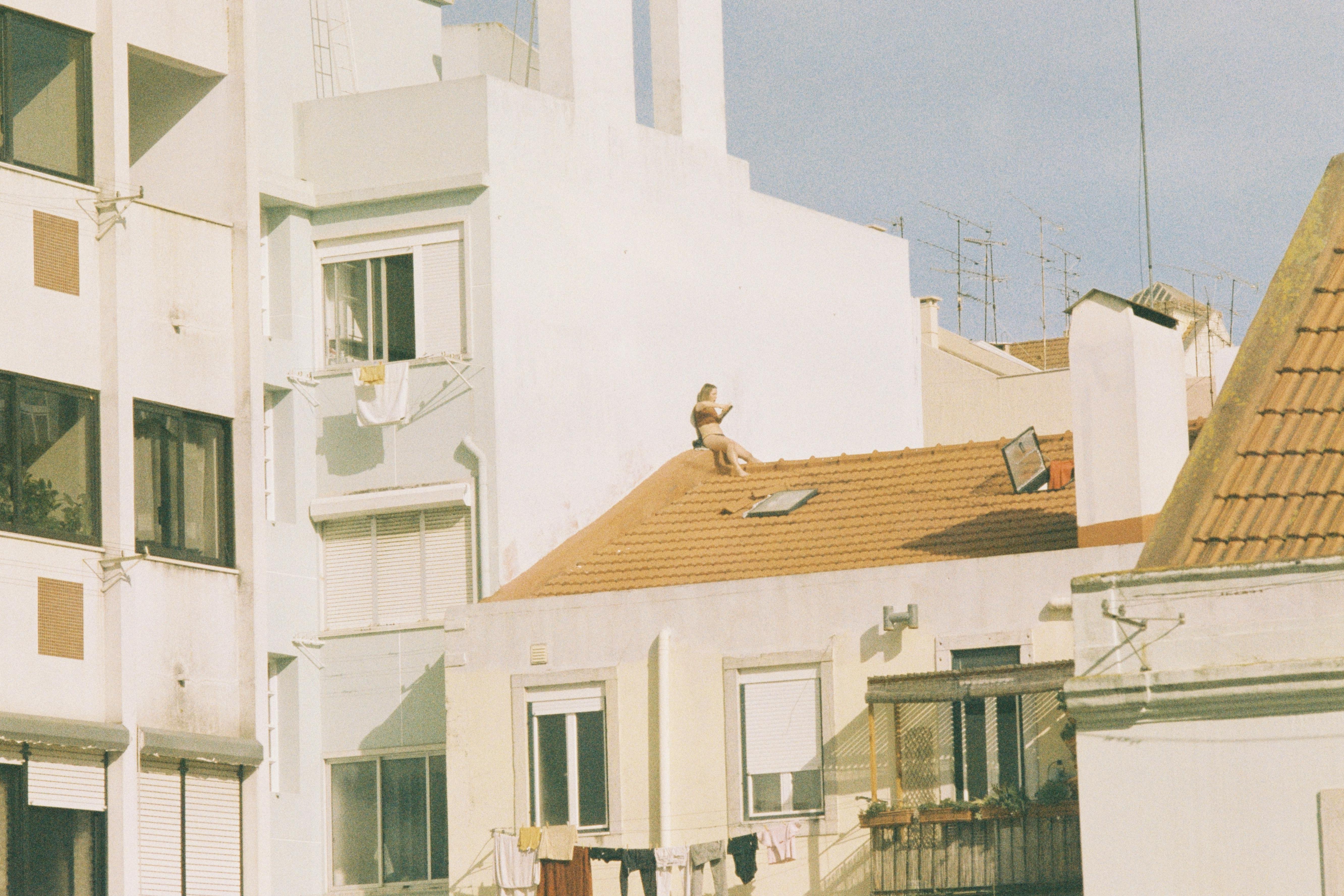 Woman Sunbathing on Rooftop · Free Stock Photo