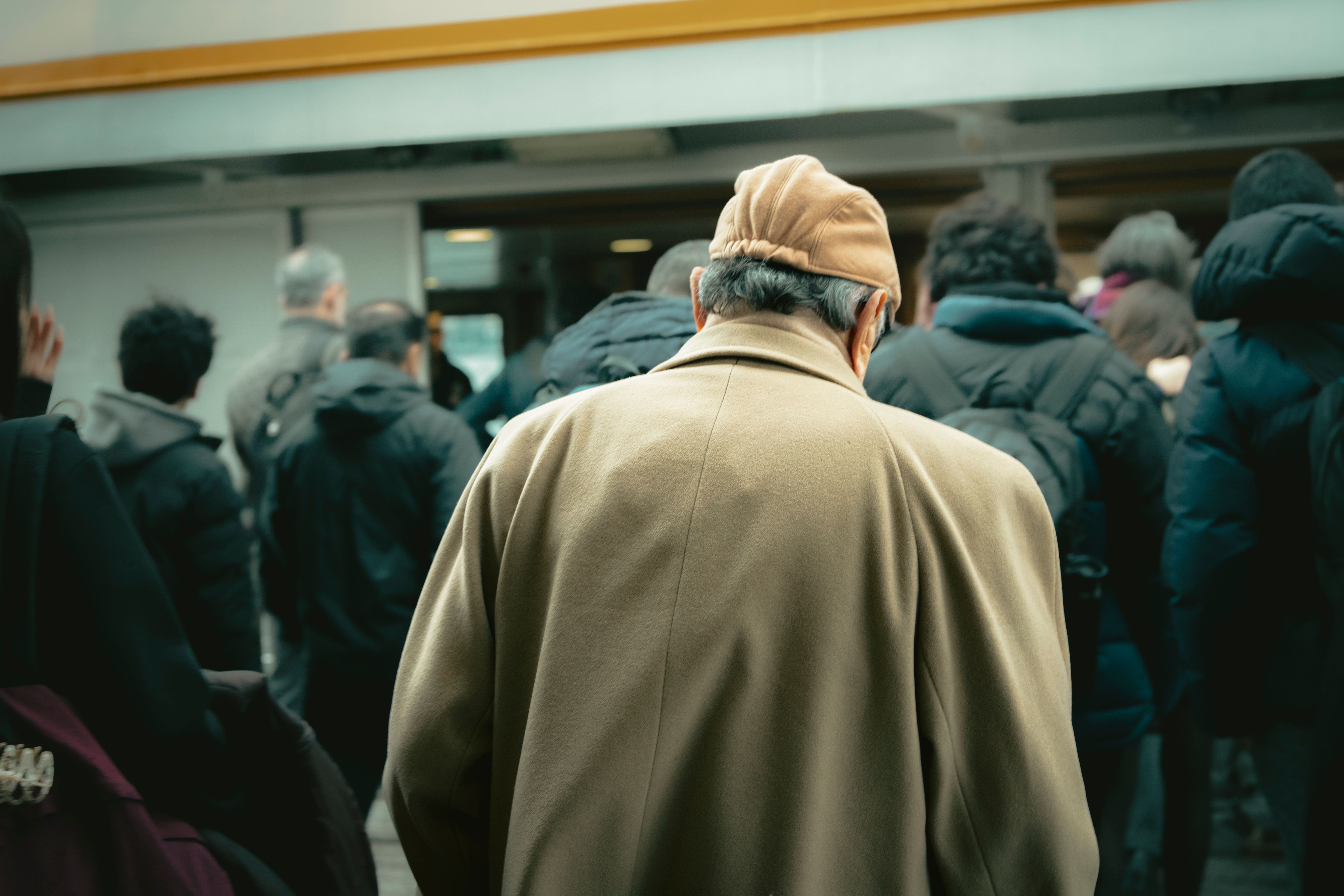 Man in Beige Coat and Beige Ivy Cap · Free Stock Photo