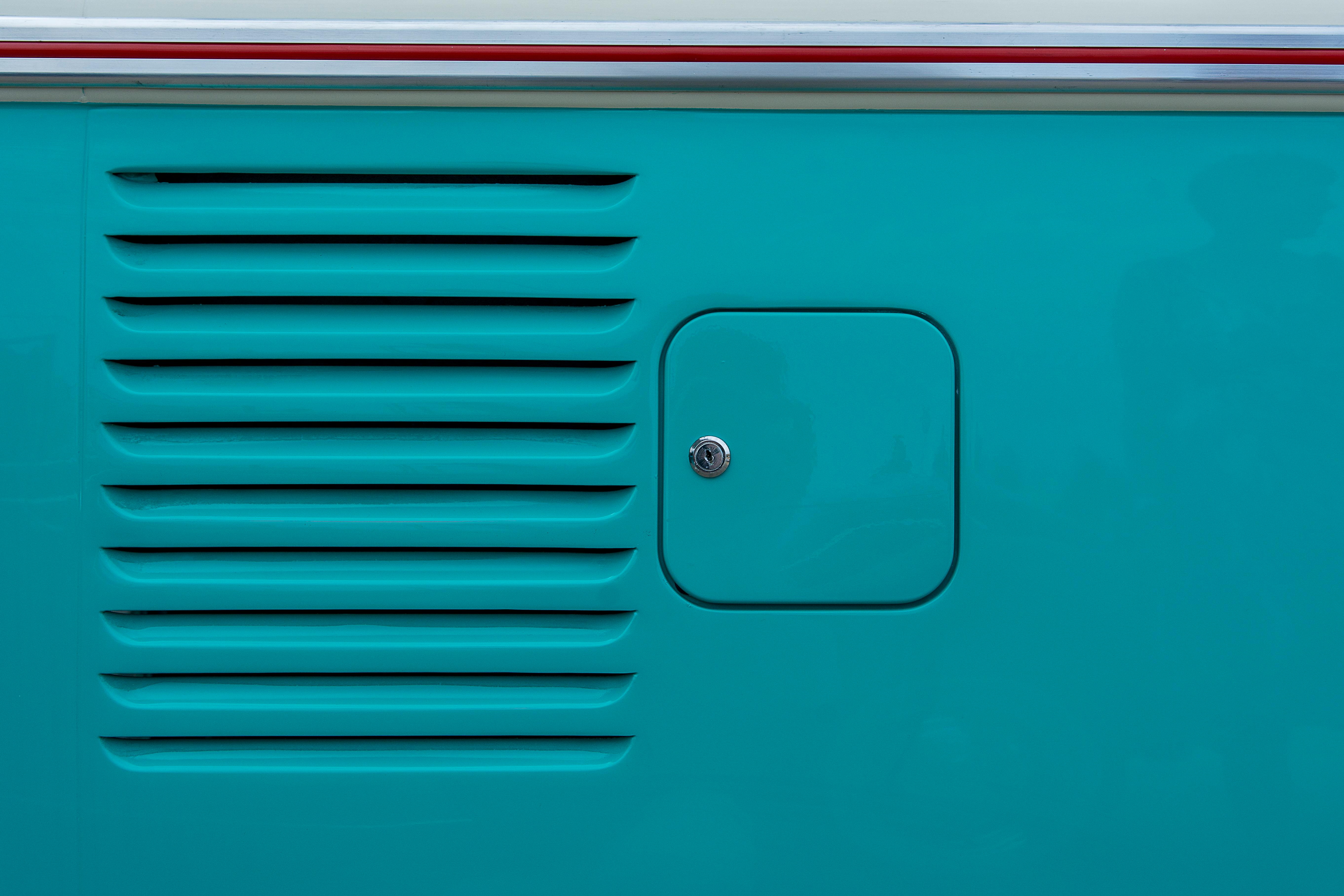 A close up of the side of a turquoise bus · Free Stock Photo