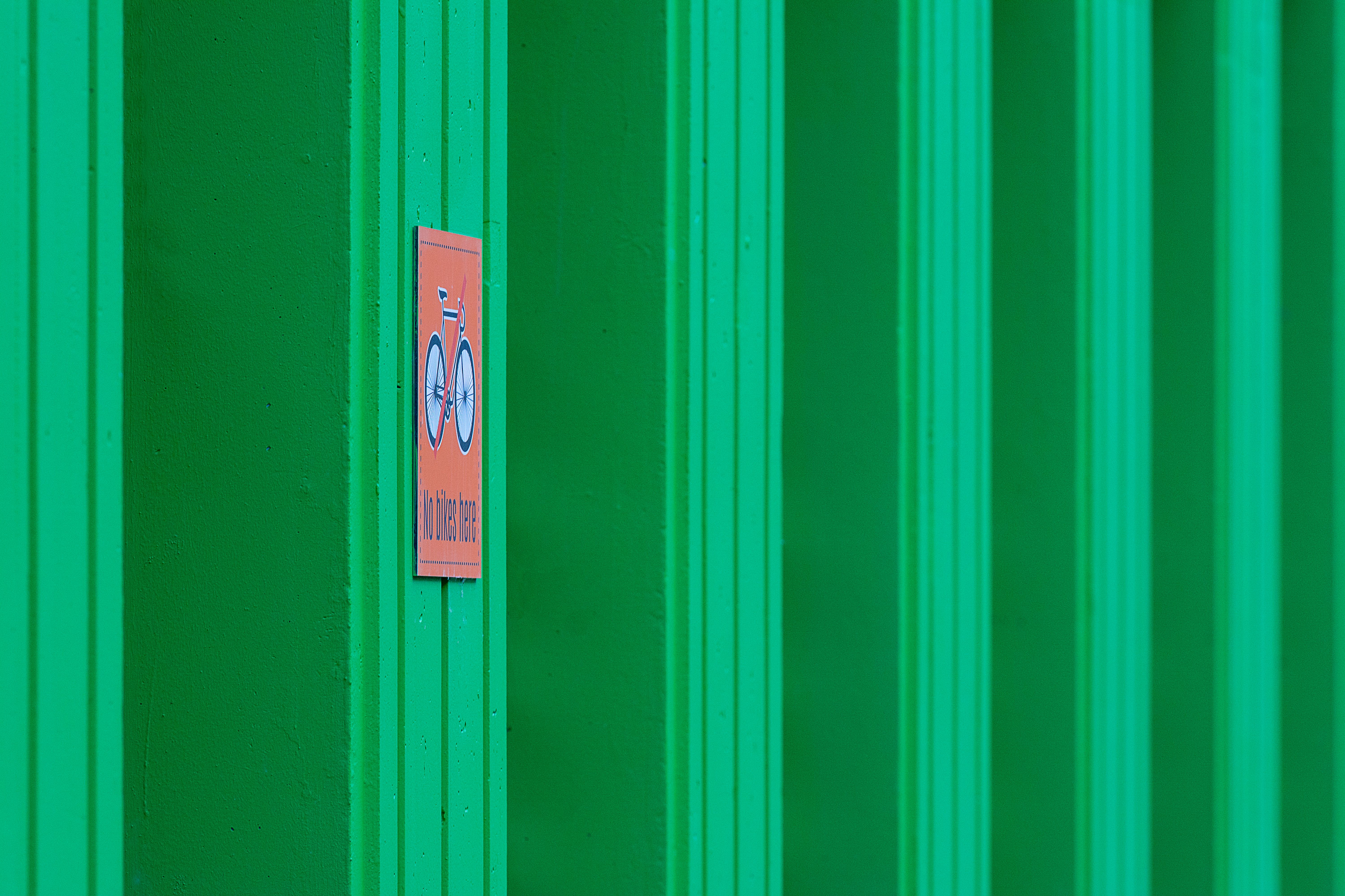 Prohibition Sign on Green Wall · Free Stock Photo