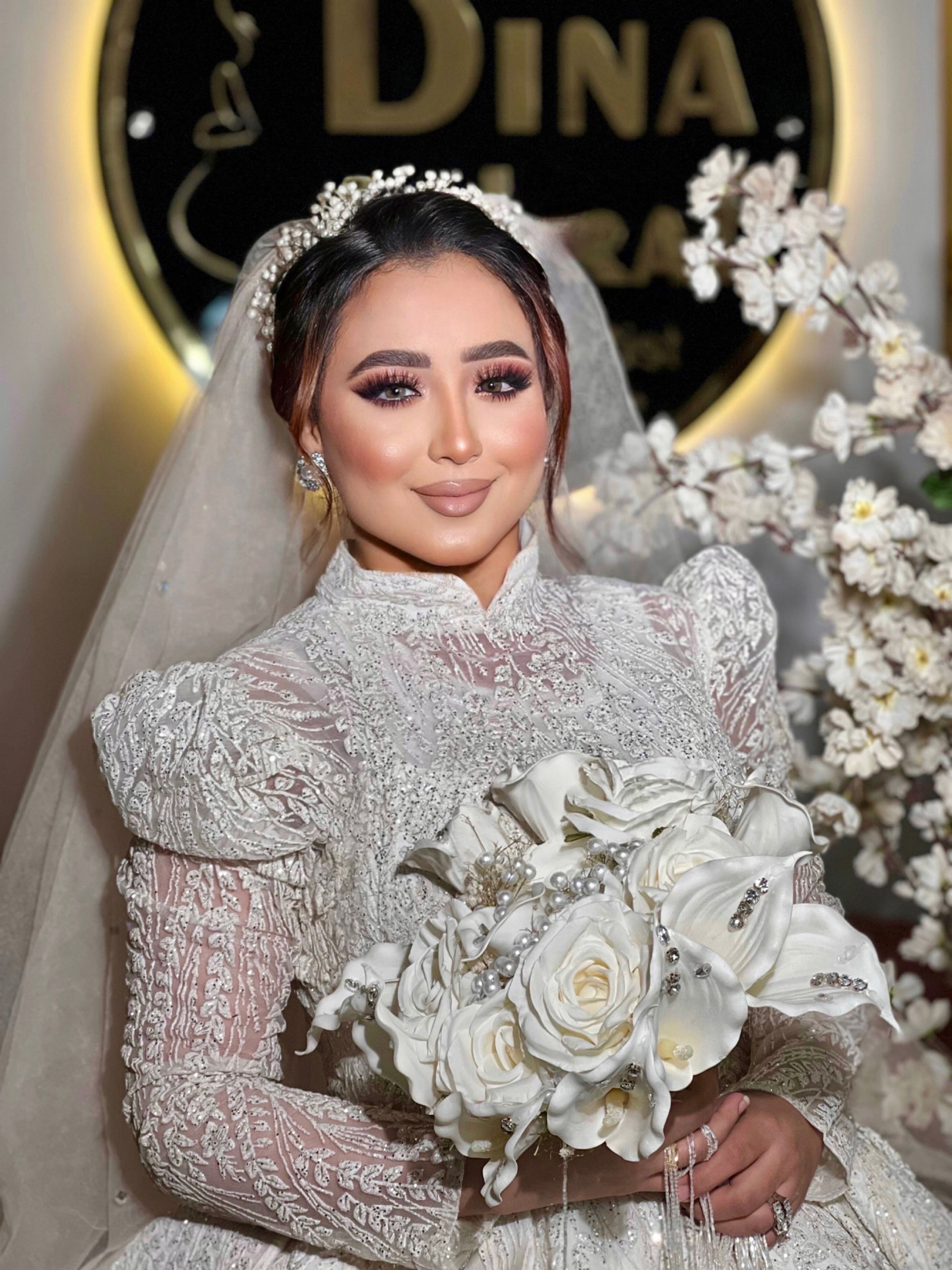 Bride in Traditional White Wedding Dress and Veil Holding a Bouquet ...