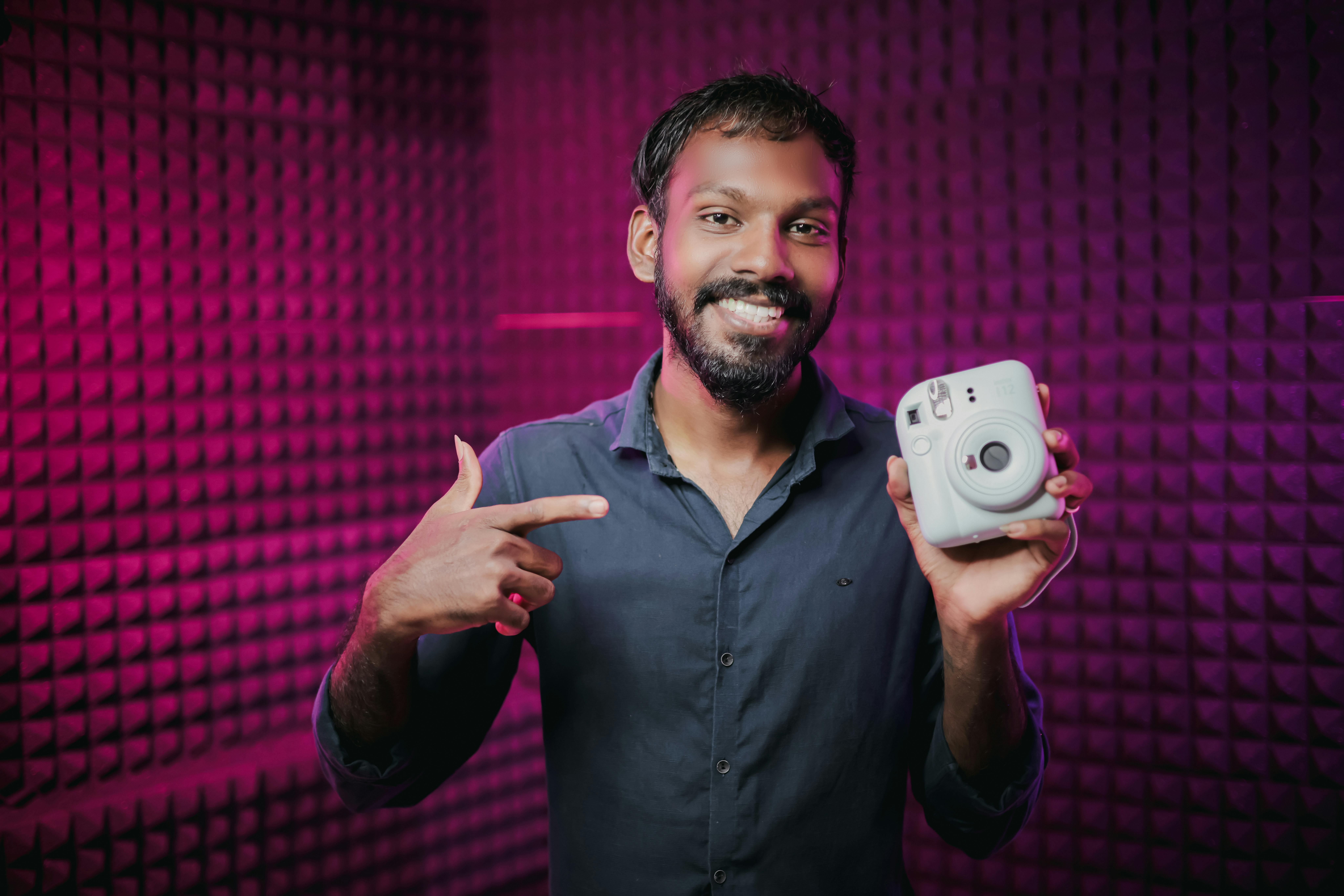 Man Holding an Instant Camera Fujifilm Instax Mini 12 · Free Stock Photo