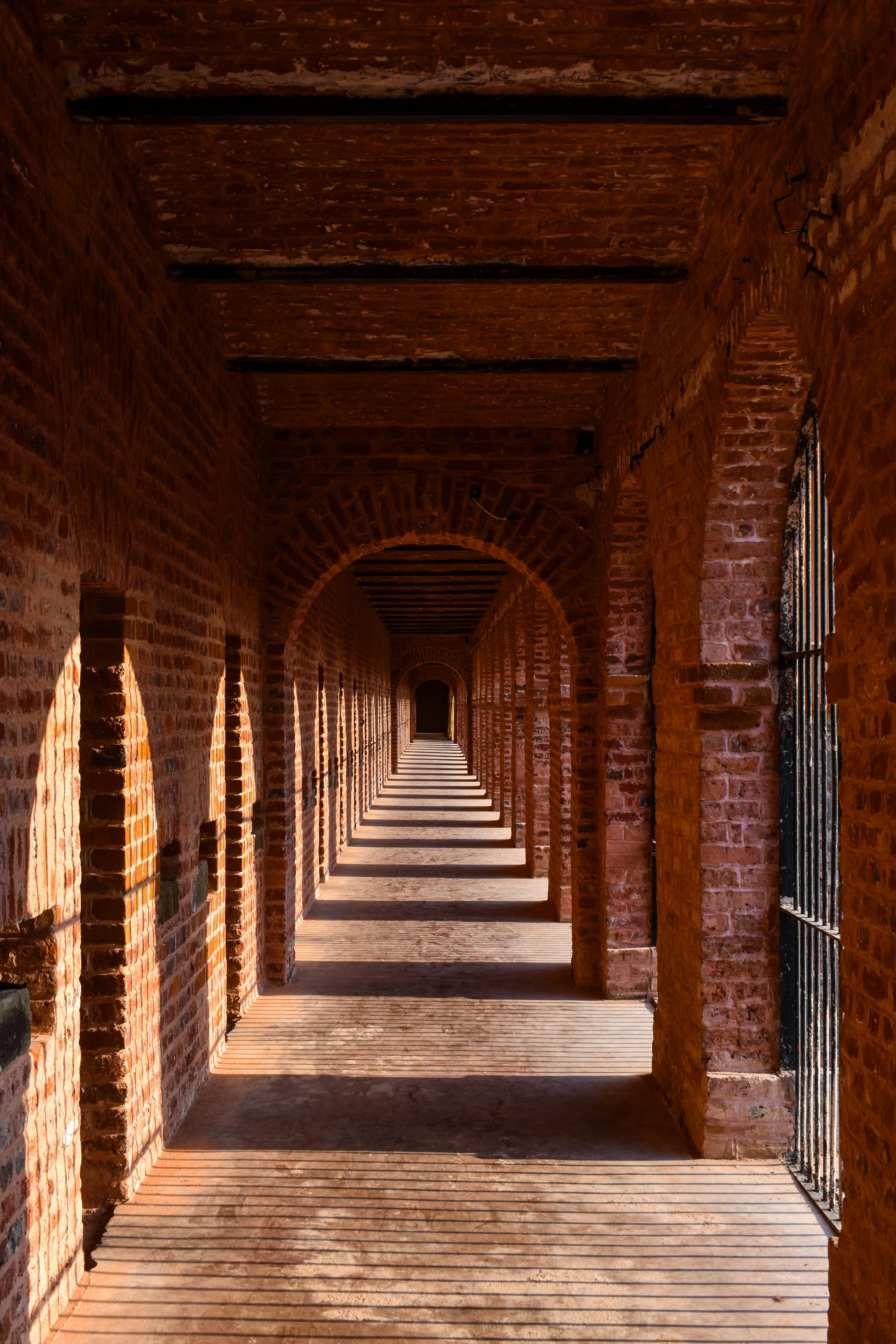 Brick Arcade of a Cellular Jail in Perspective · Free Stock Photo