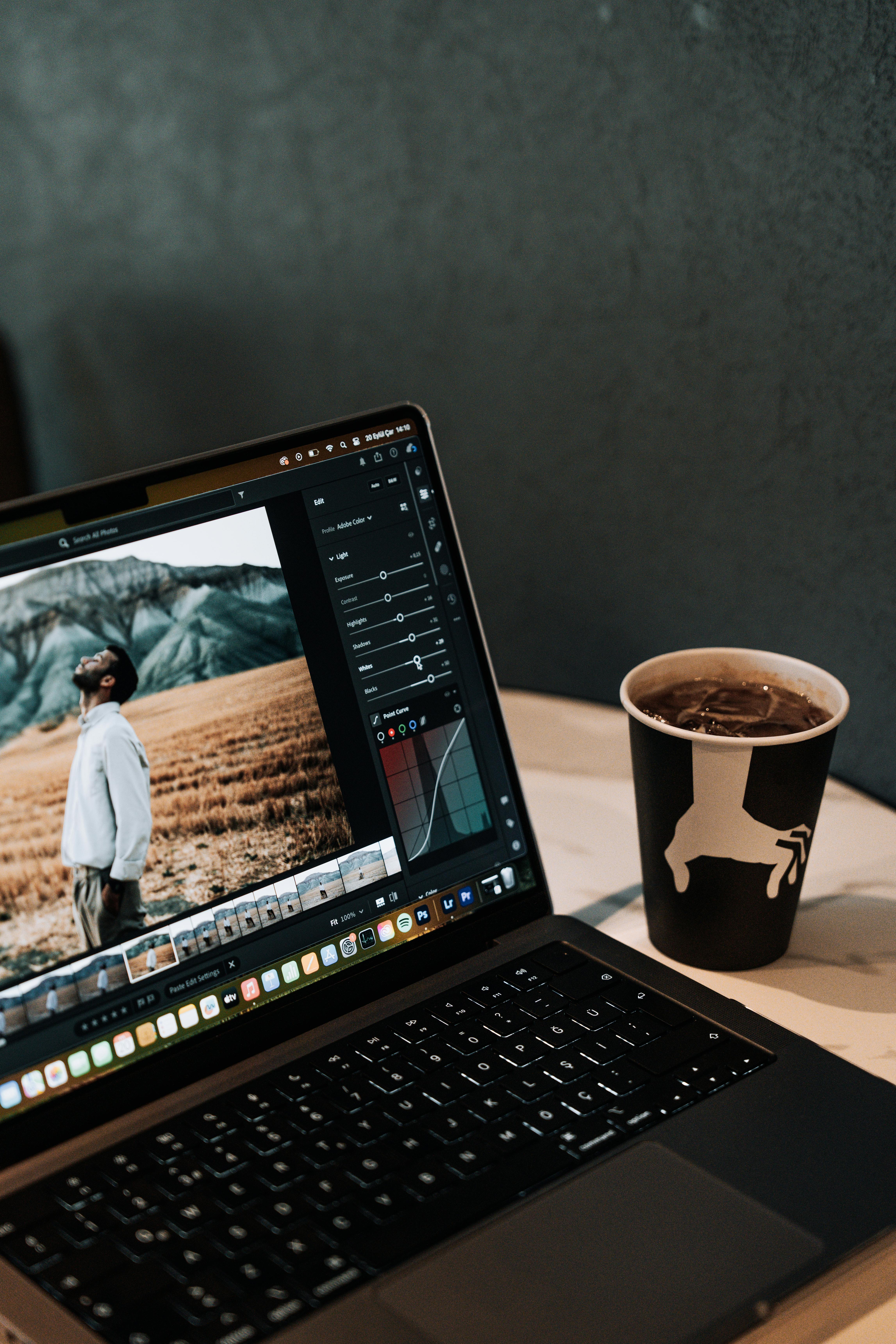Laptop Displaying Photos and a Cup with a Drink on the Table · Free ...