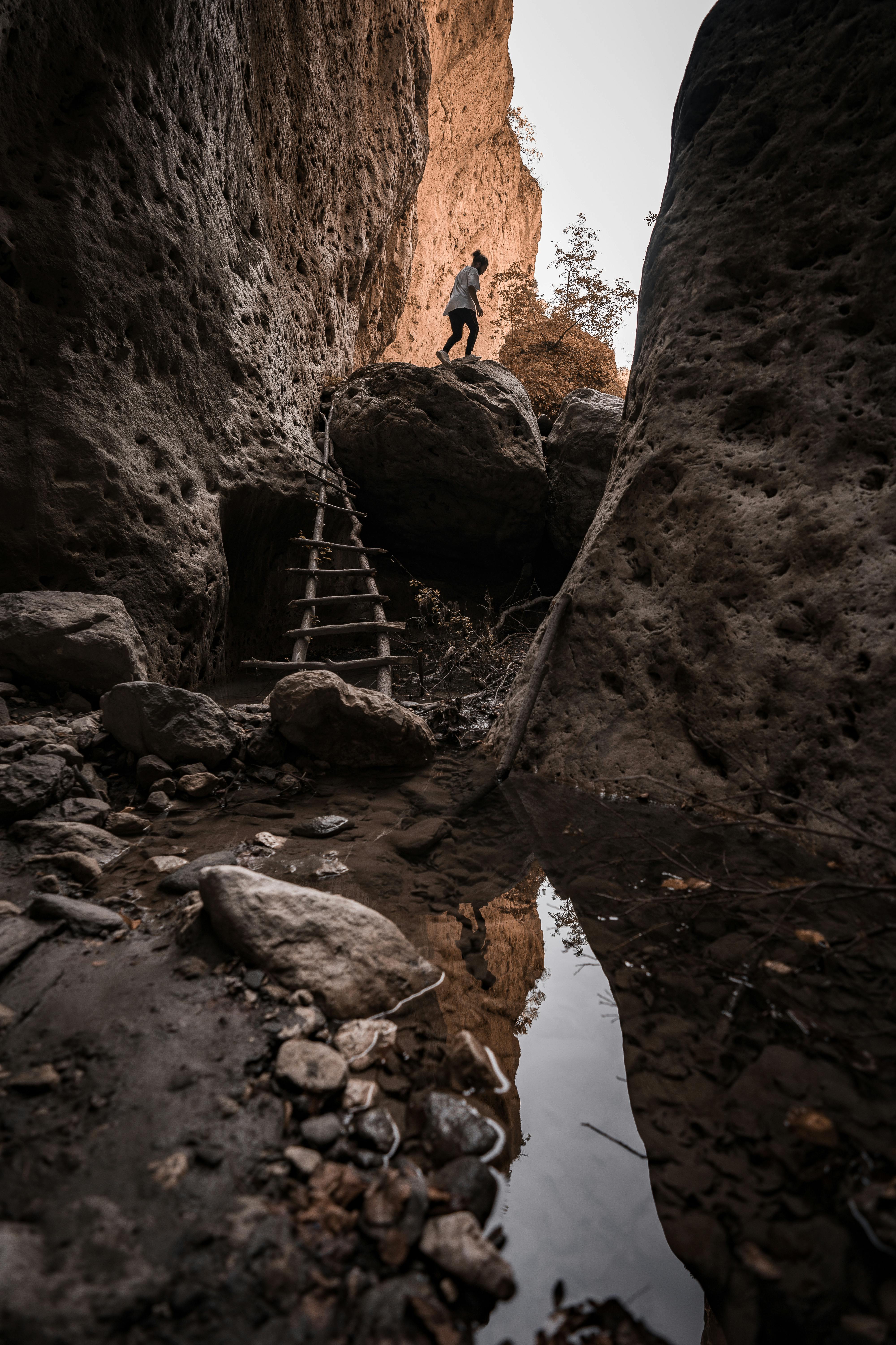Person Walking in a Gorge between Large Stone Walls · Free Stock Photo