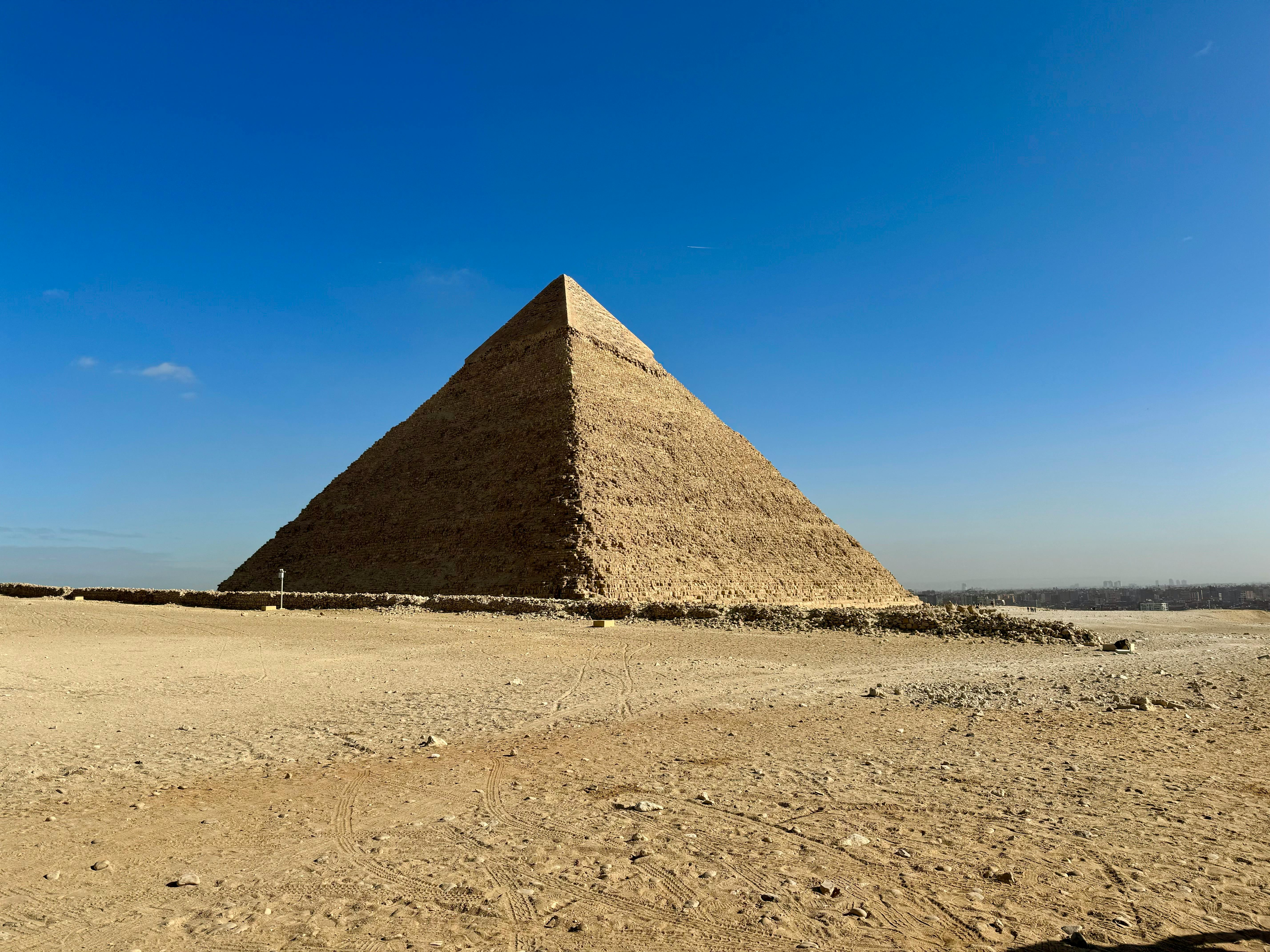 The Pyramid of Khafre stands majestically in Giza's desert, showcasing ...