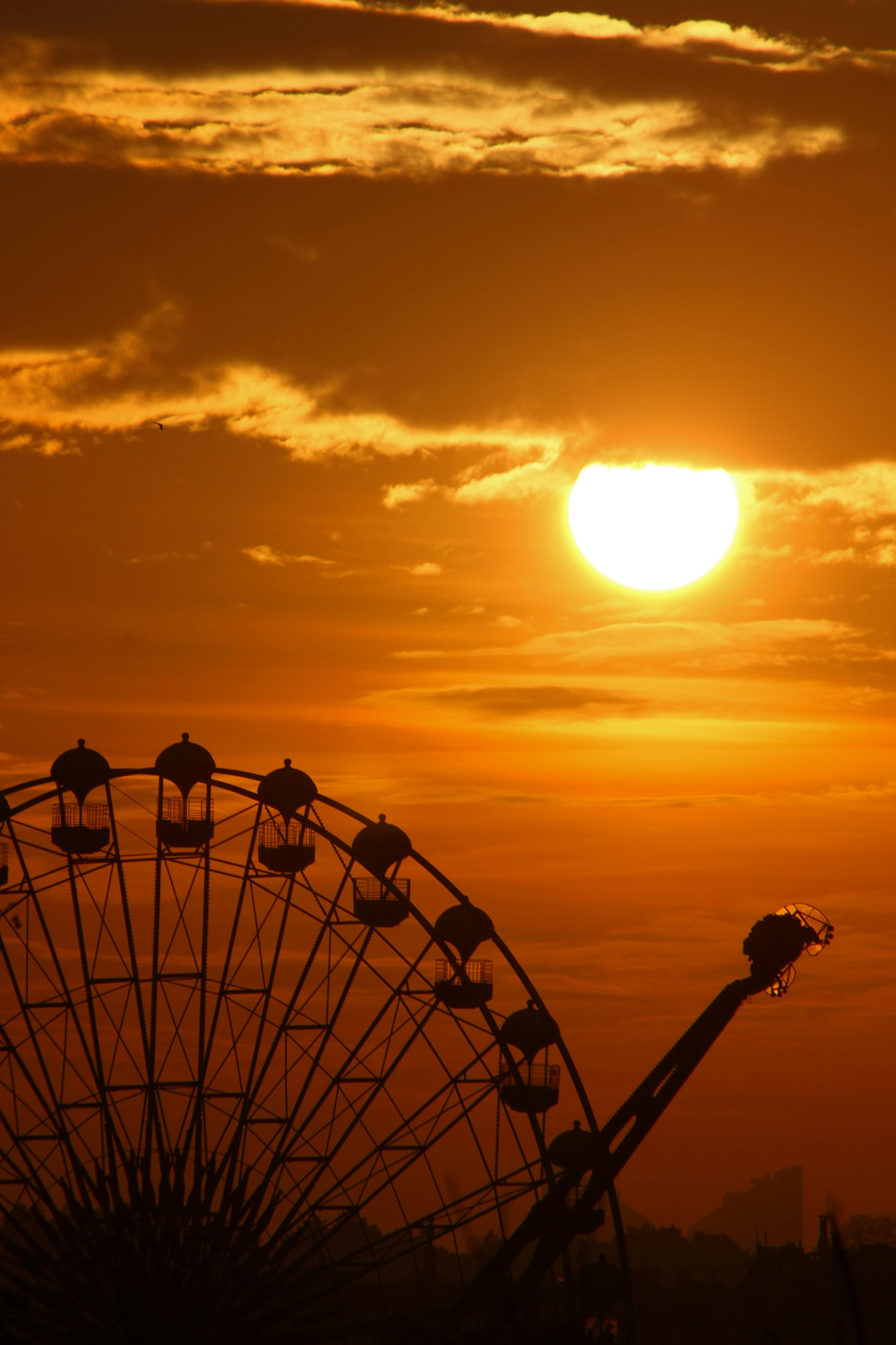 Silhouetted Fairground Rides at Sunset · Free Stock Photo