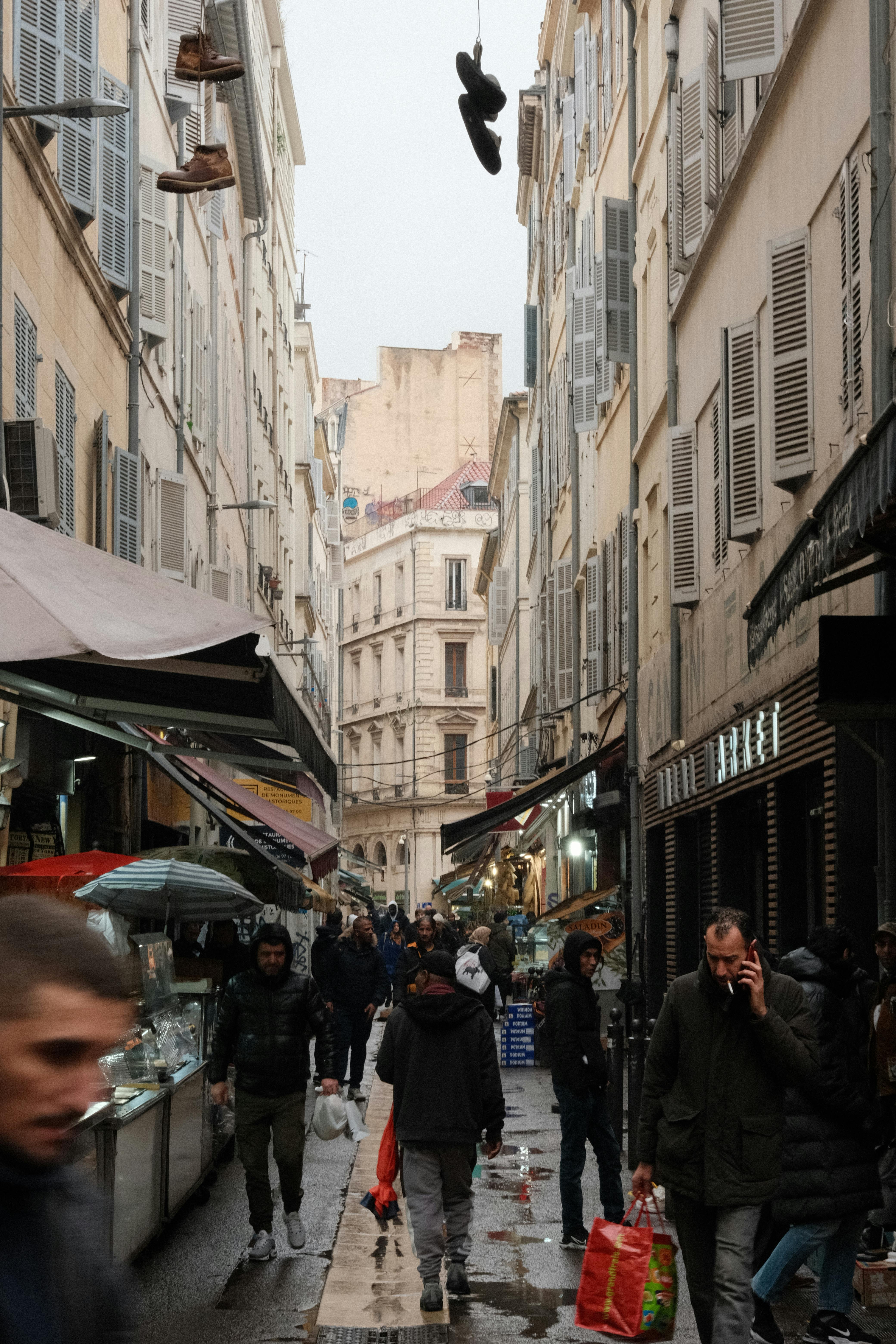 A Crowded Narrow Alley between Buildings with Wooden Window Shutters ...