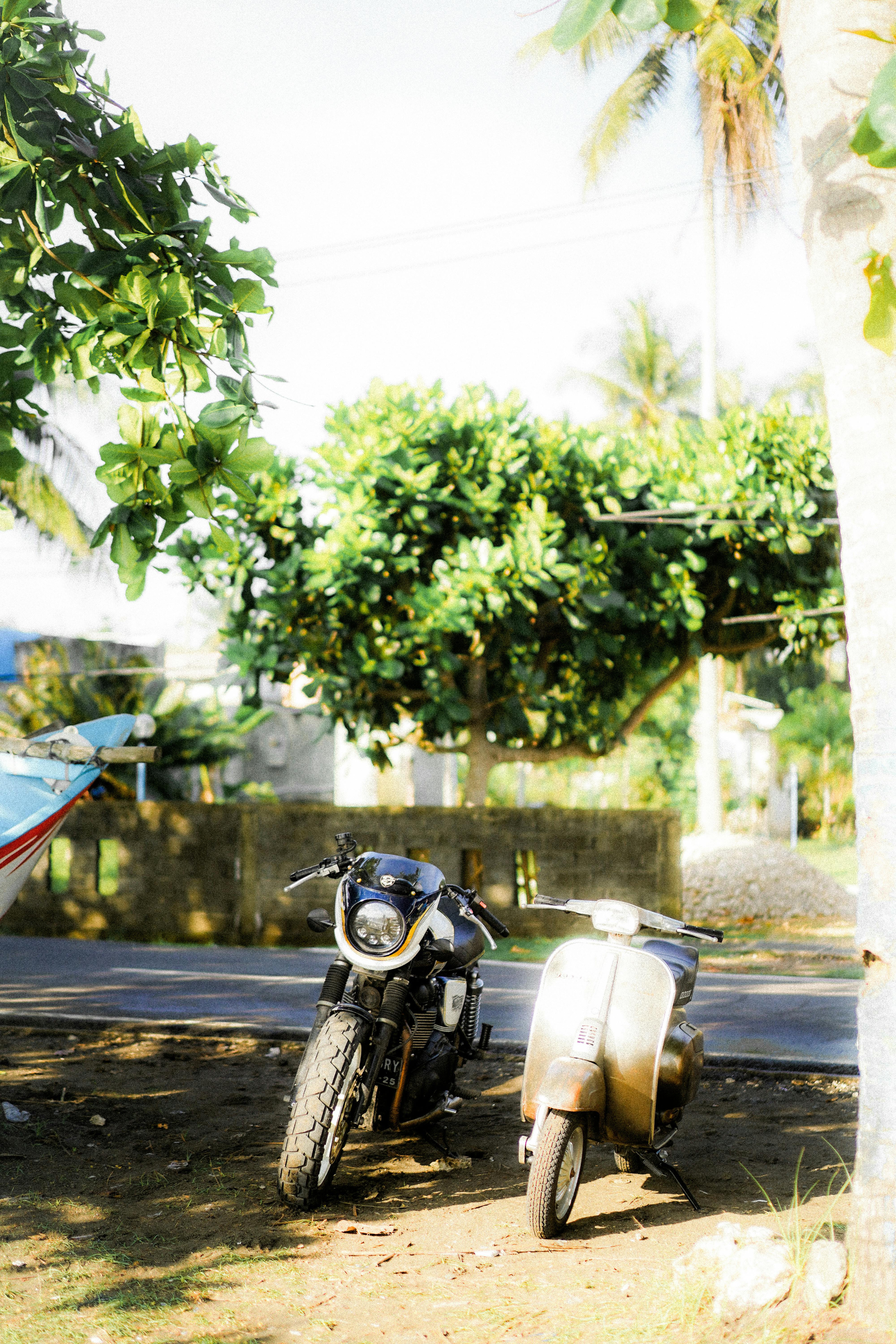 Motorcycle and Motor Scooter on Side of Rural Road · Free Stock Photo