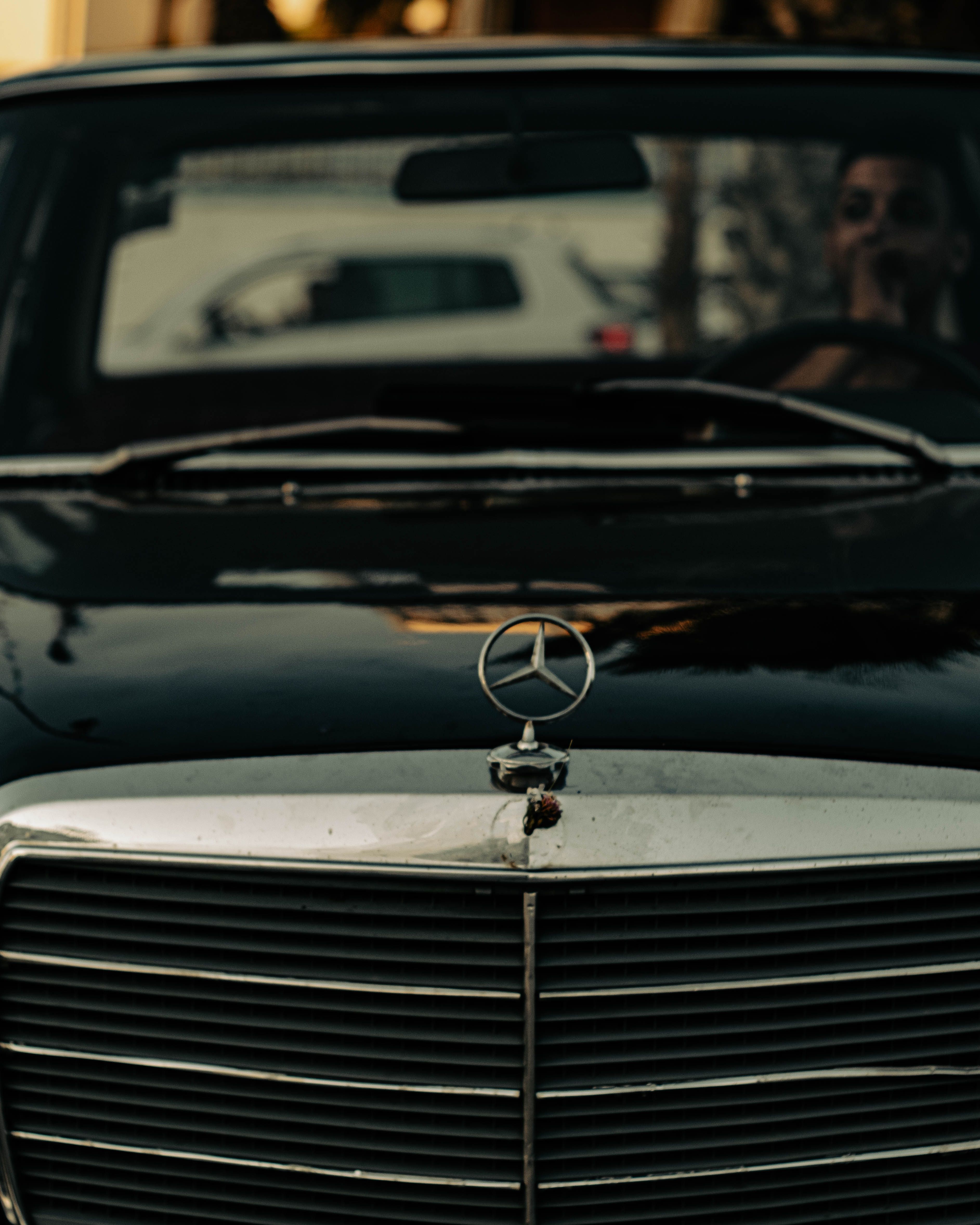 Sticking Out Car Logo on a Black Car · Free Stock Photo