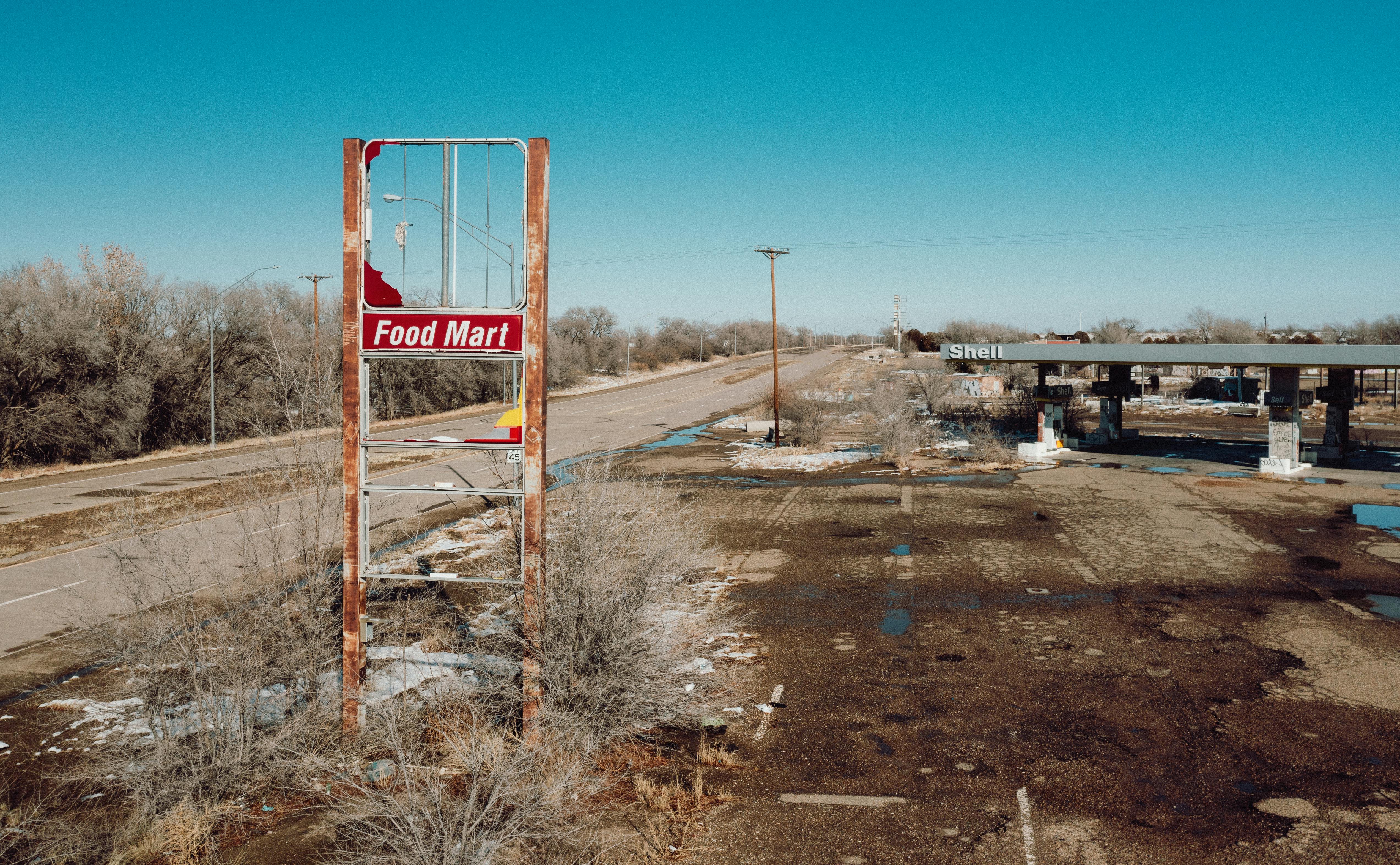Decaying Sign by Road through Countryside · Free Stock Photo