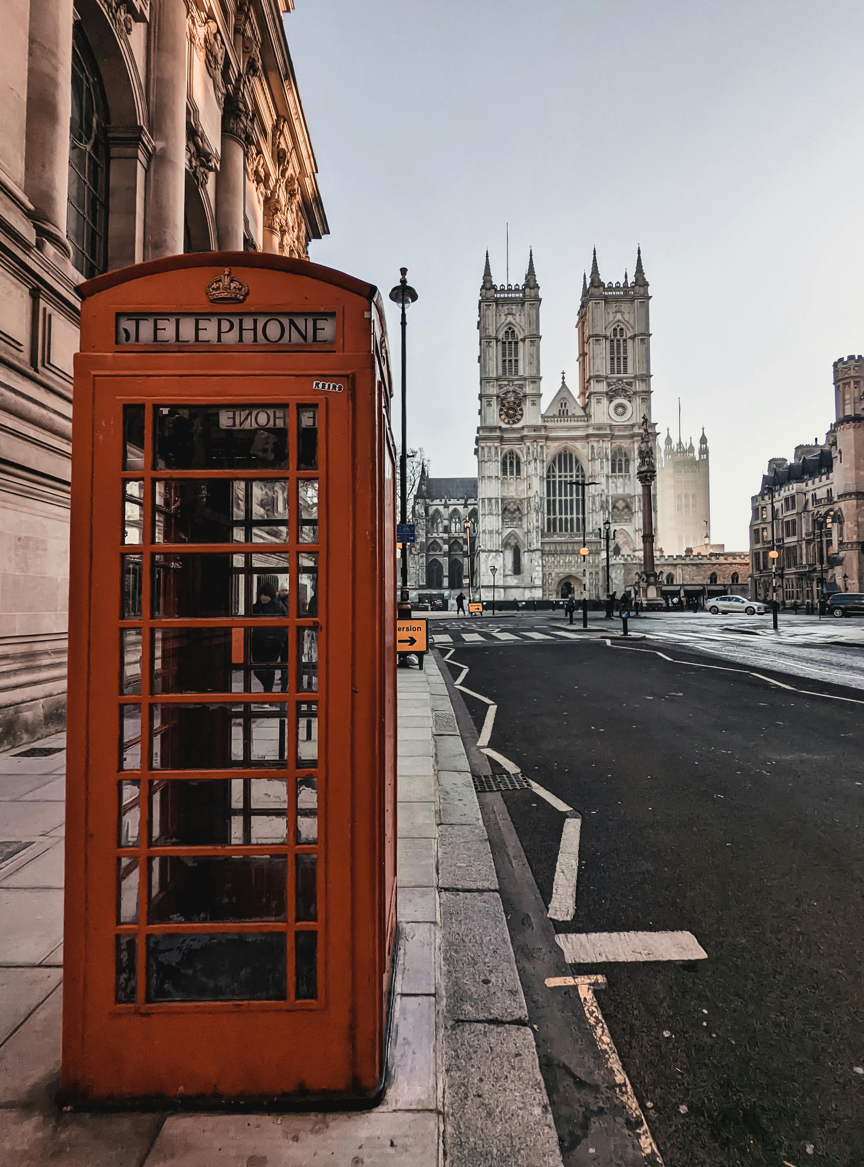 View of a Red Telephone Booth and the Westminster Abbey in London ...