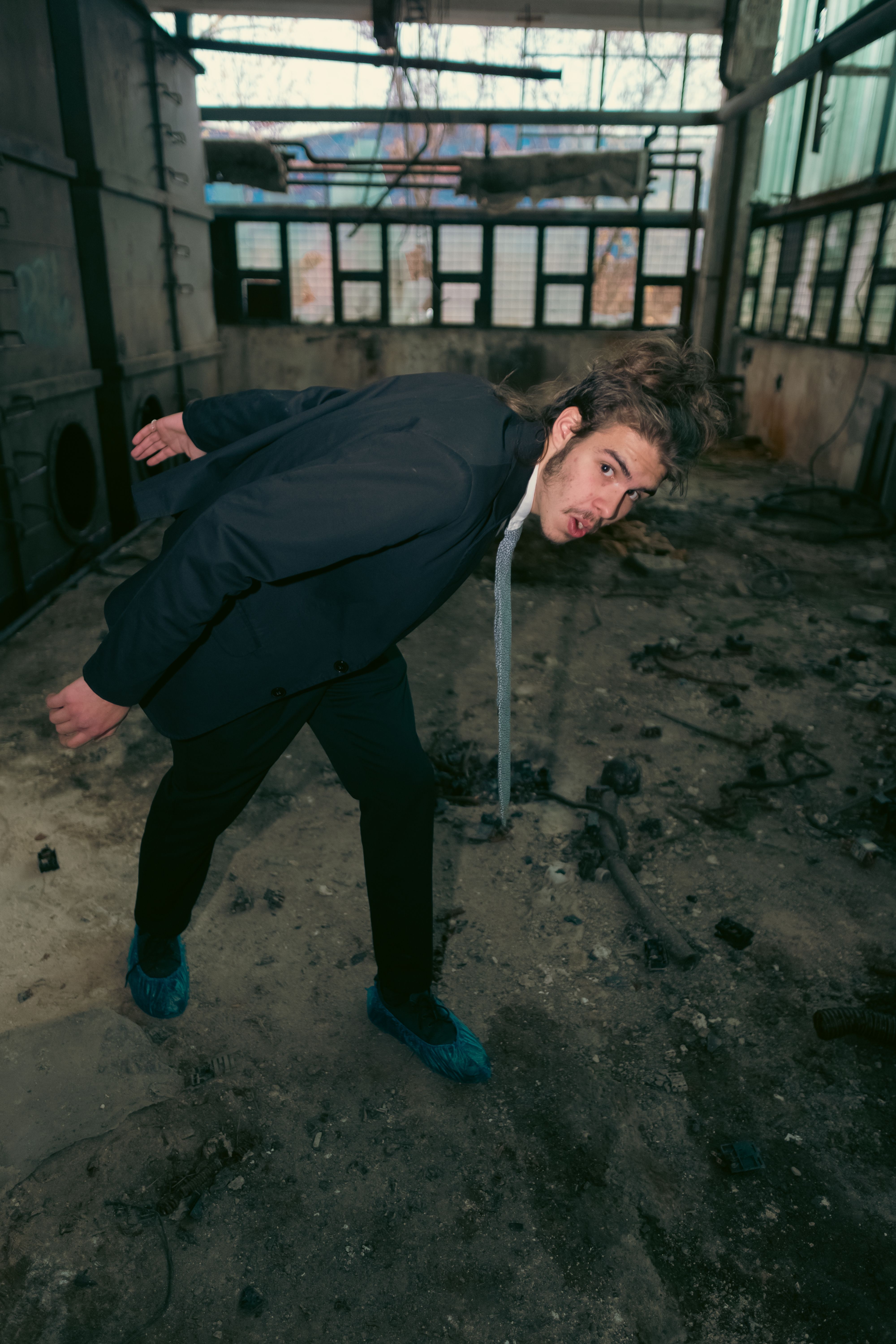 Man in Abandoned Building Leaning · Free Stock Photo