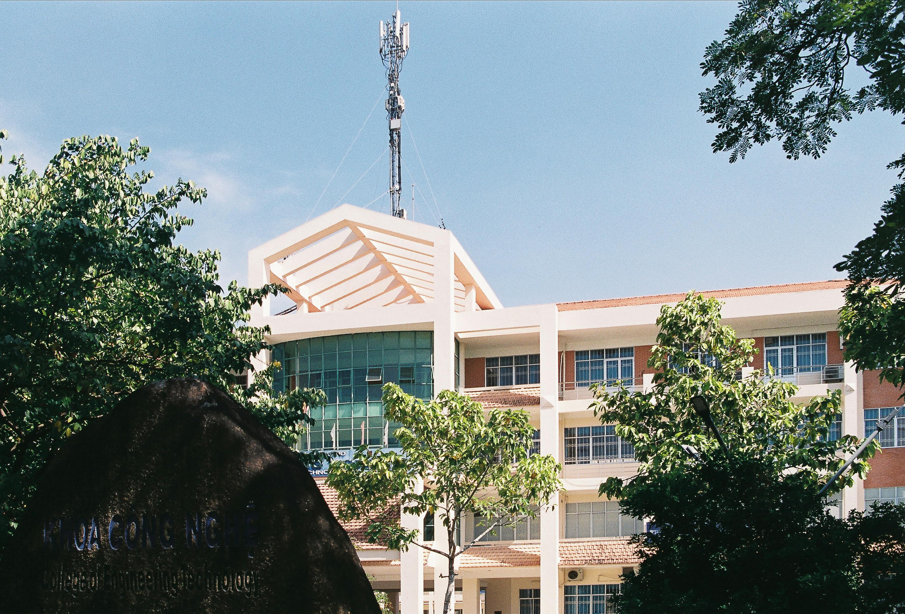 Modern Building behind Trees · Free Stock Photo