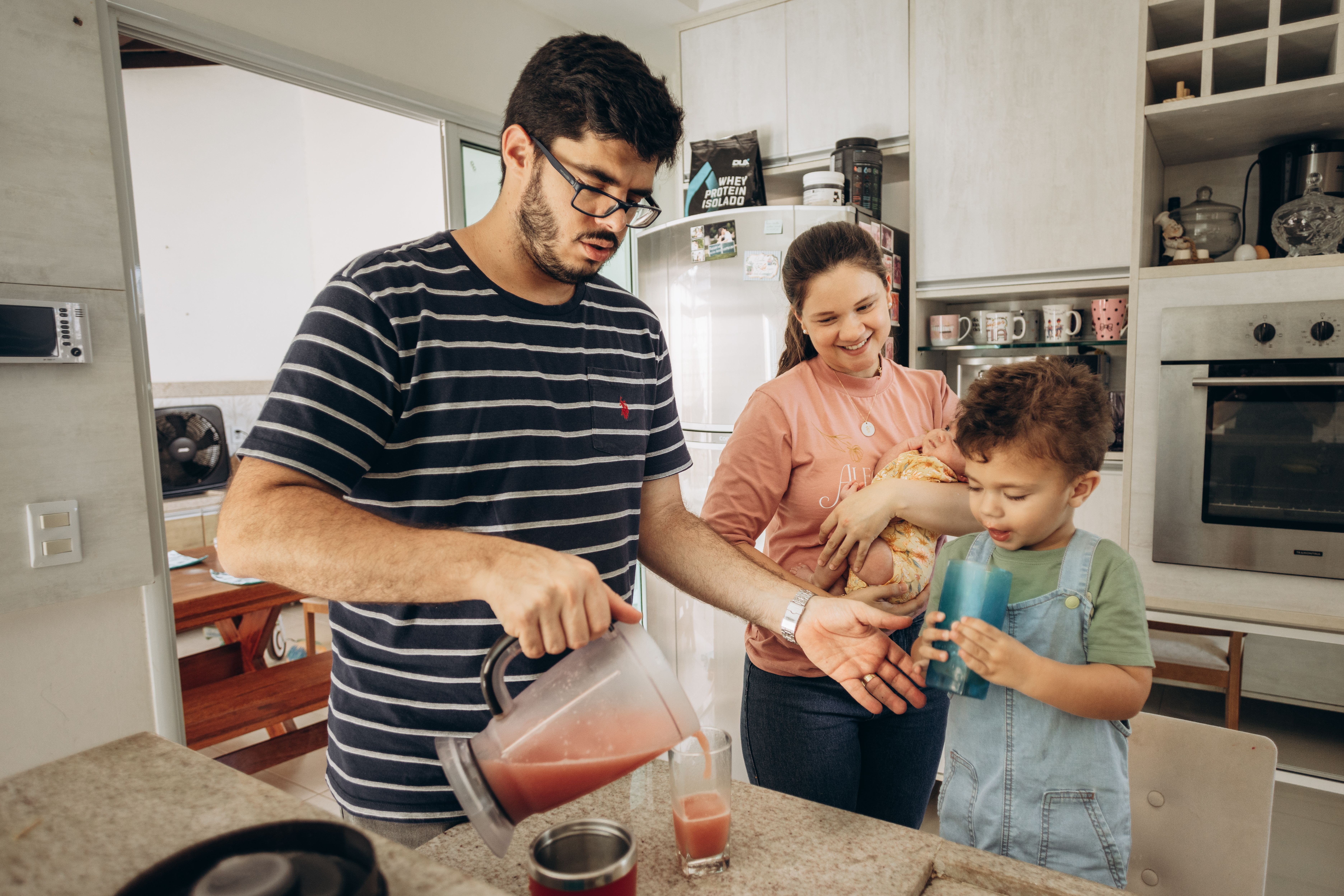 Father Pouring Juice in Kitchen · Free Stock Photo