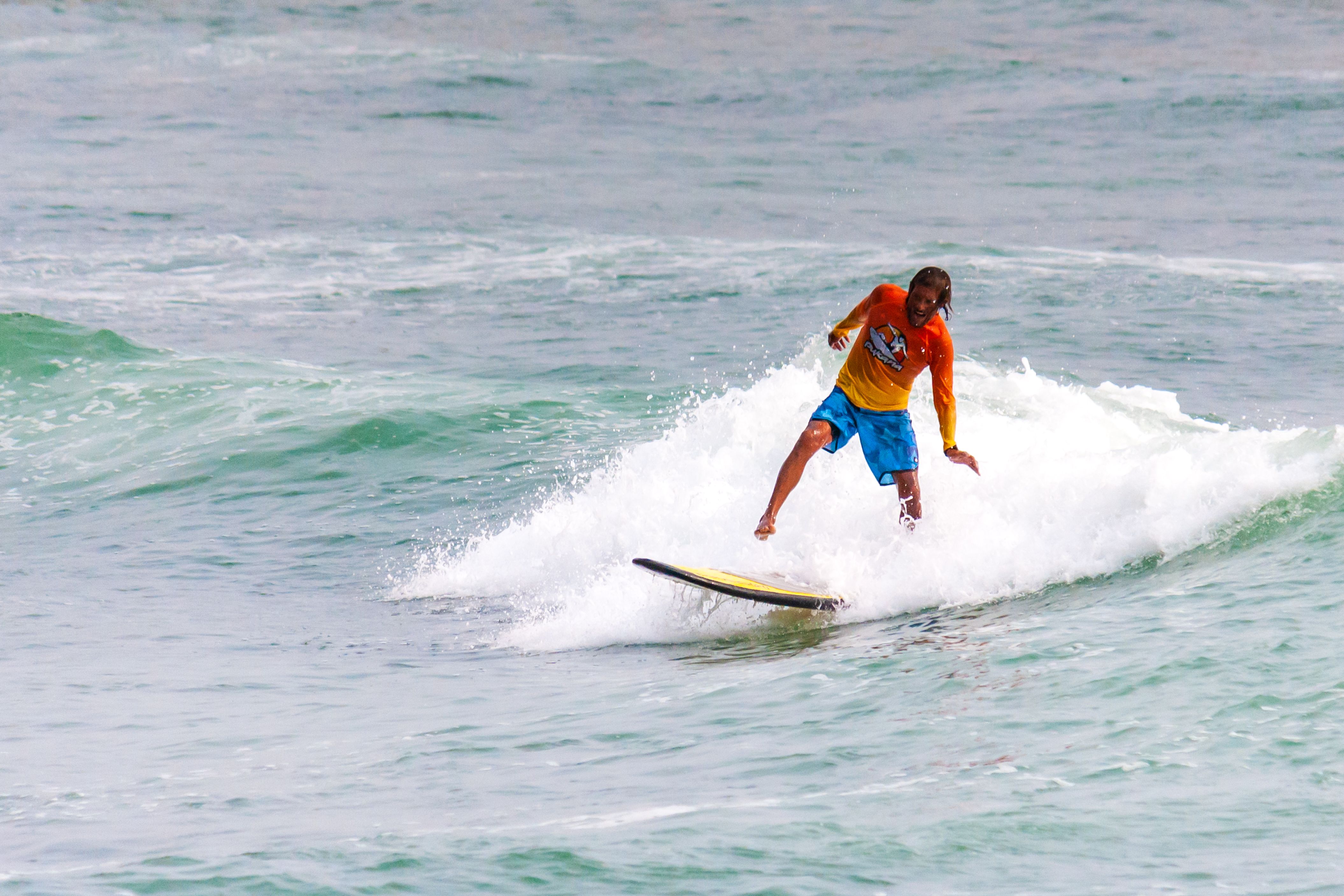 Man Surfing on Sea Shore · Free Stock Photo