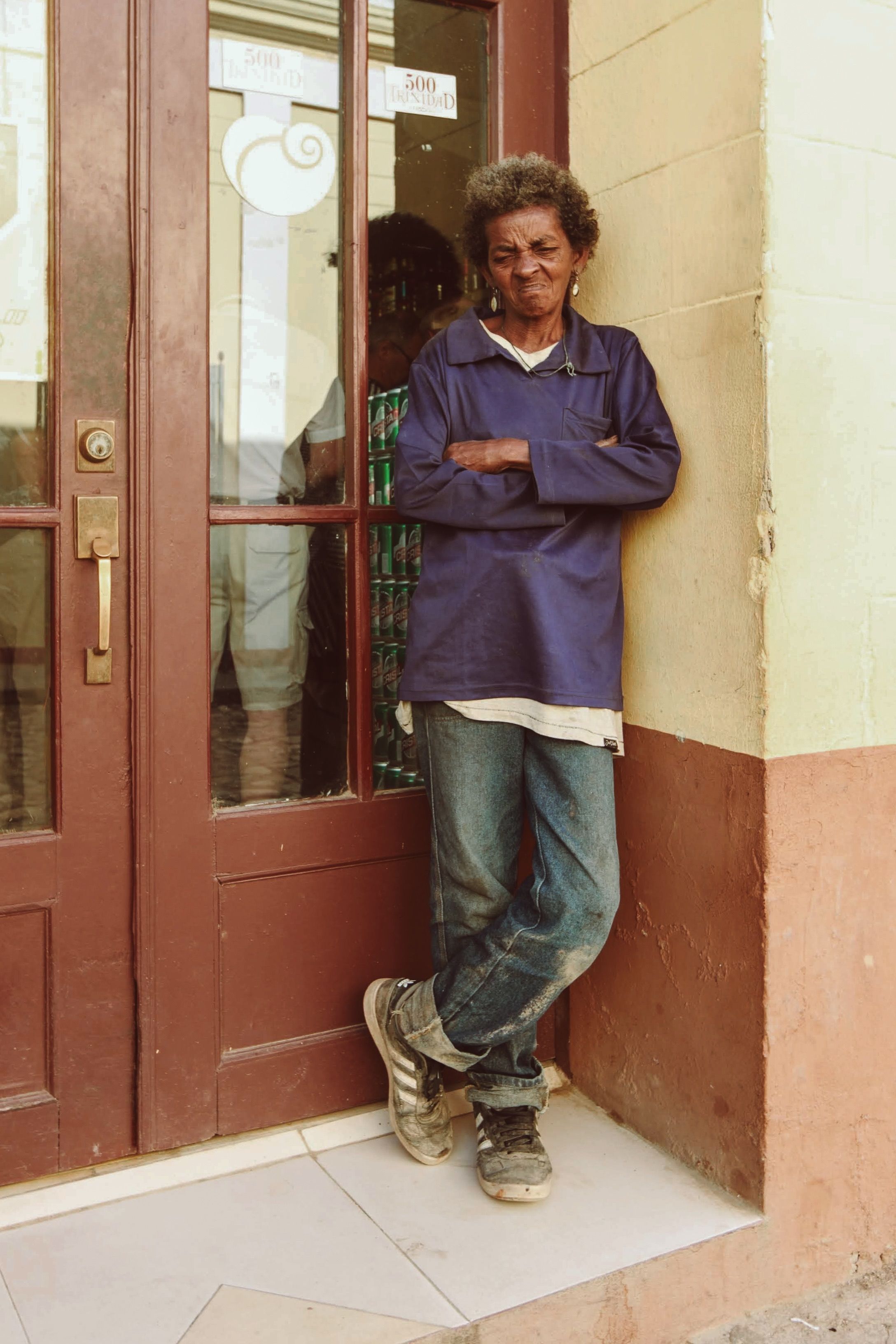 Young Man in Shabby Clothing Leaning against the Entrance Door · Free ...