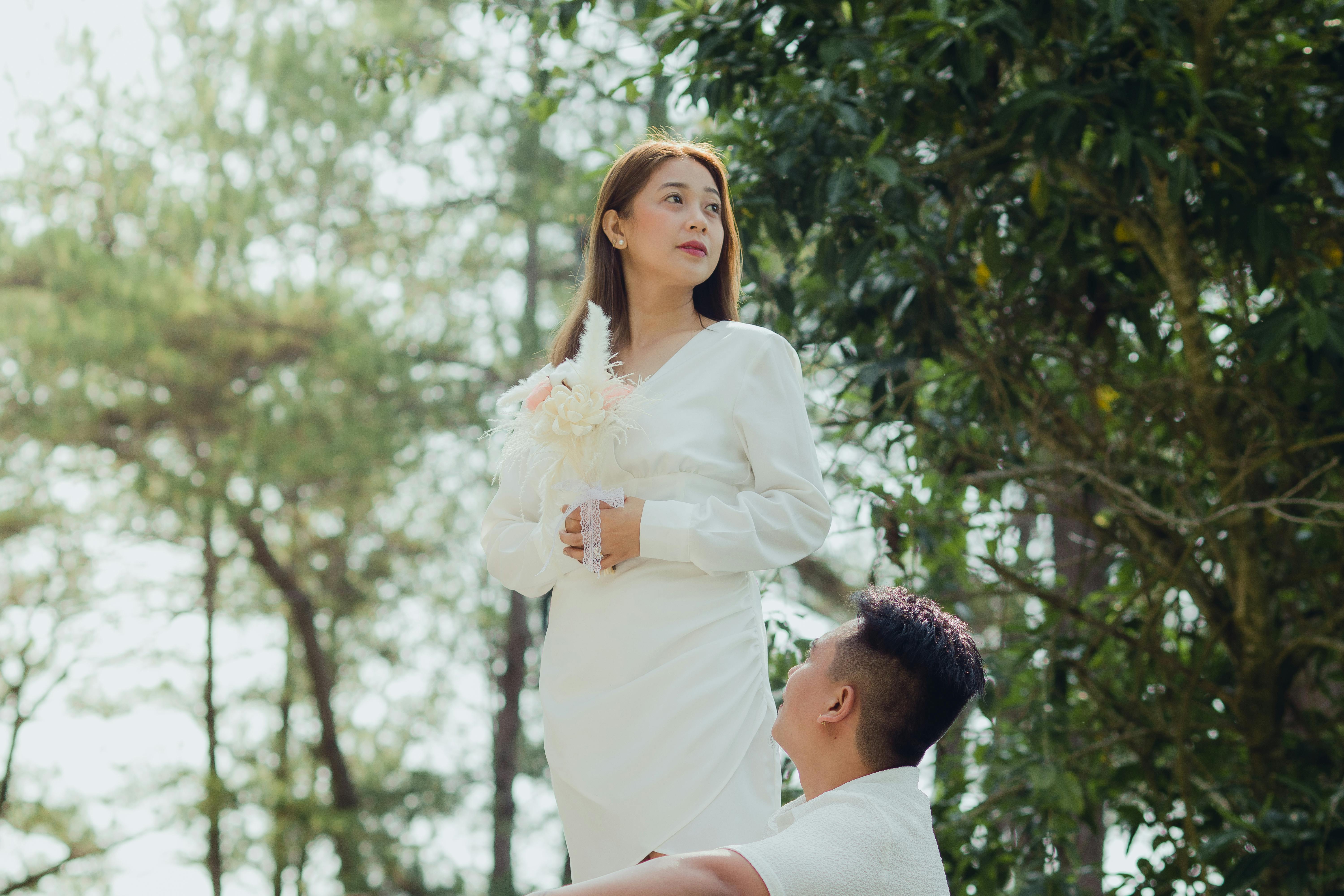 Woman in White Dress Standing over Man · Free Stock Photo