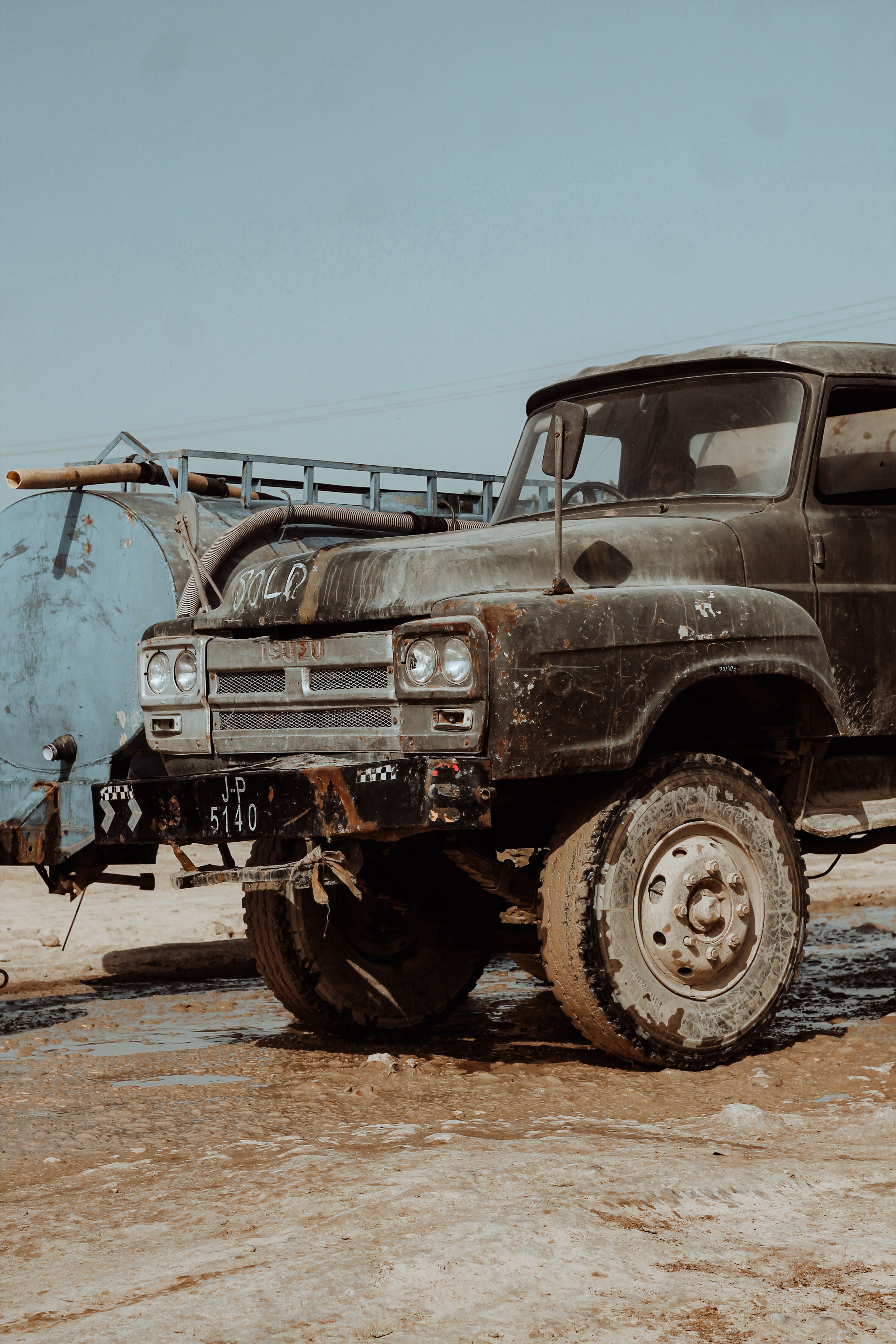 Dusty Old Truck on Muddy Road · Free Stock Photo