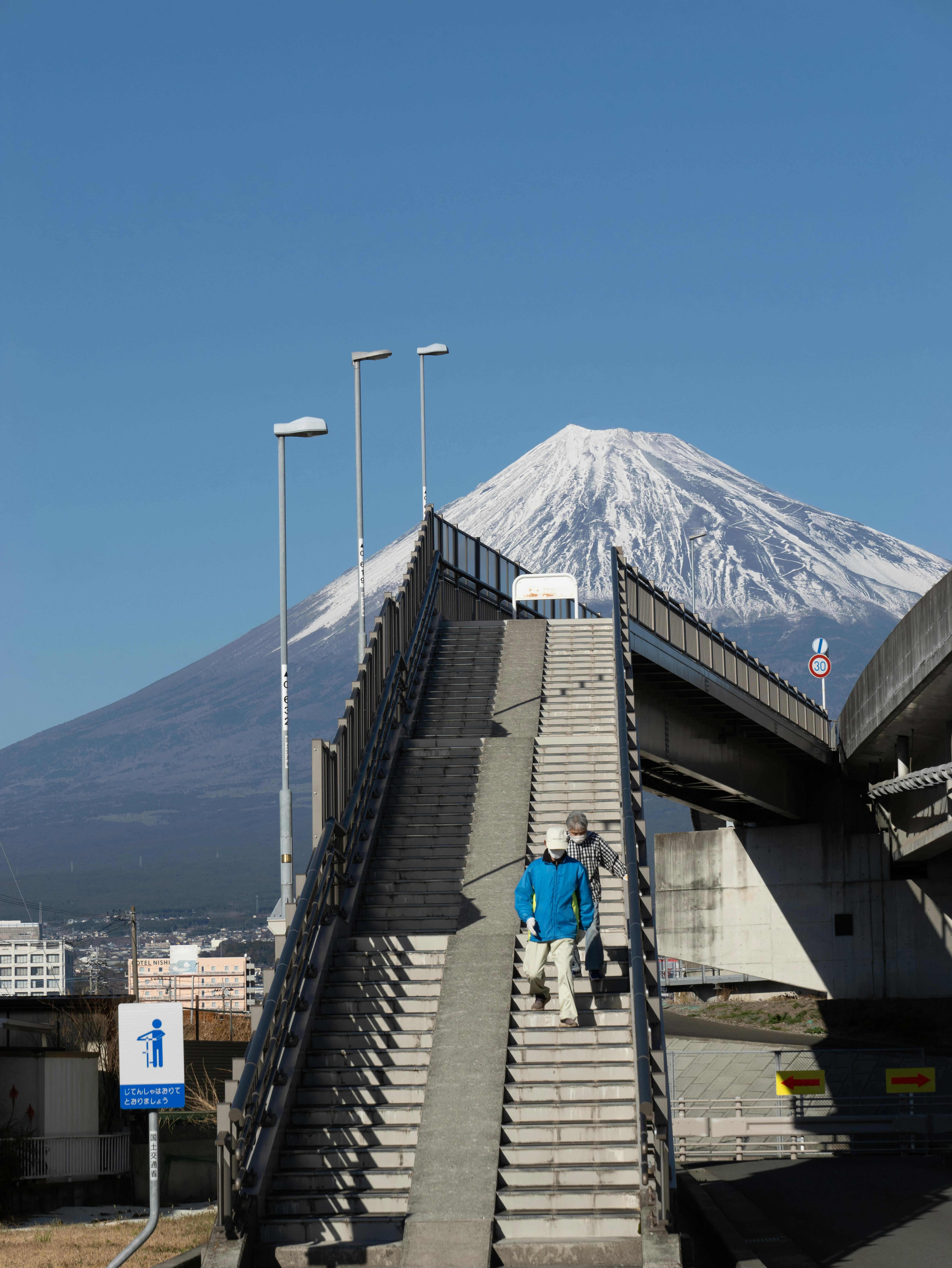 People on Steps with Mount Fuji in Background · Free Stock Photo