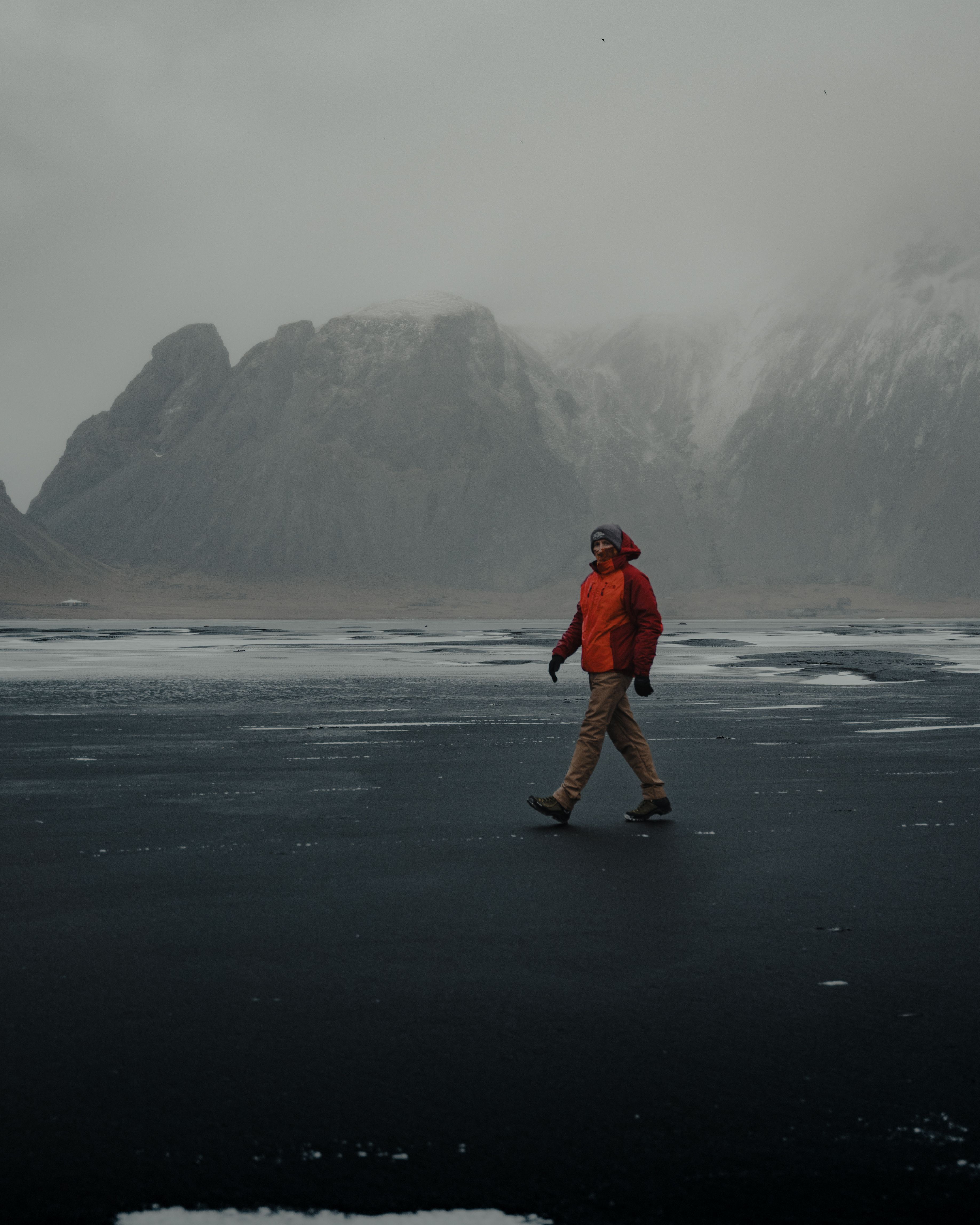 Man Walking on Black Ice on a Frozen Lake in the Mountains · Free Stock ...