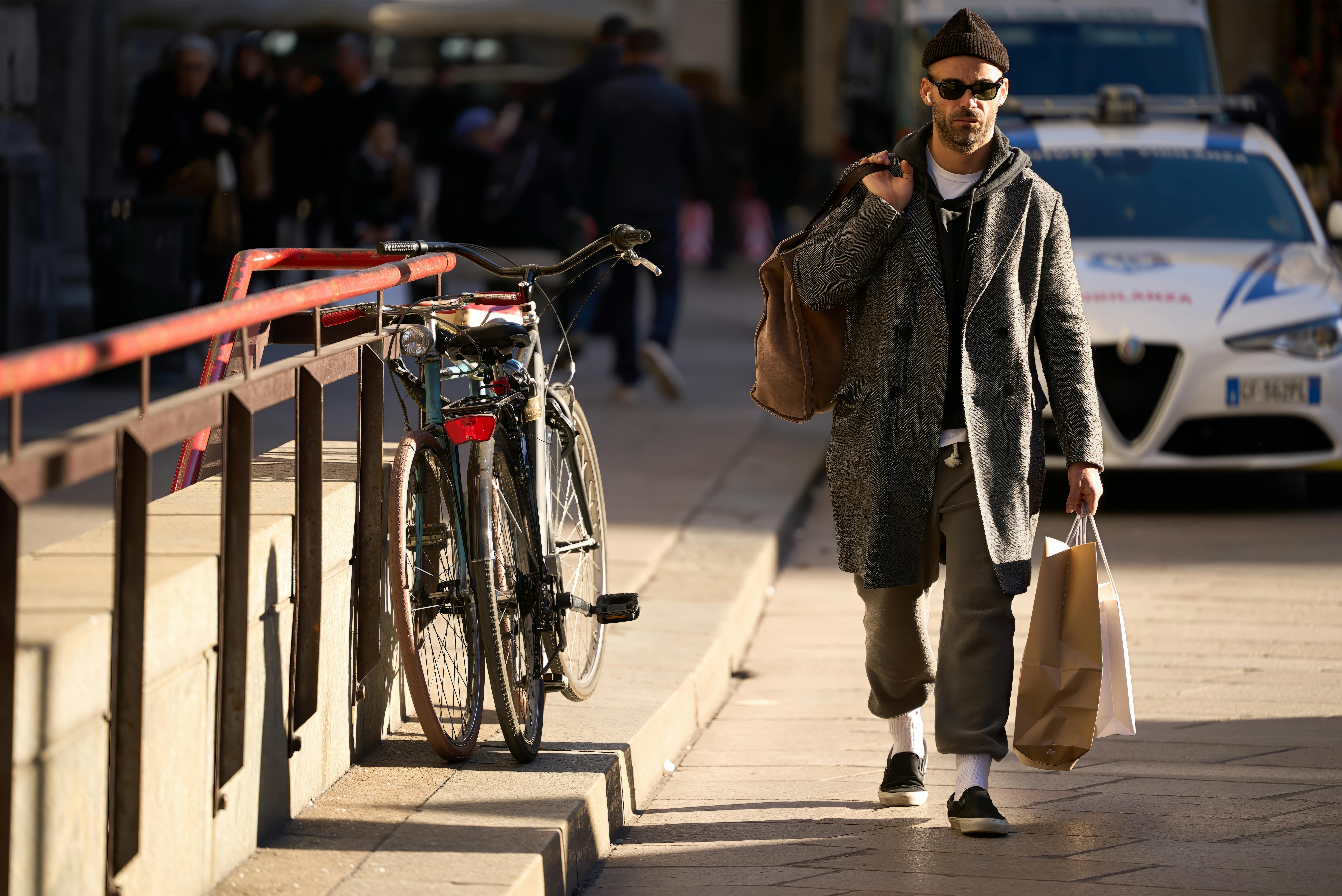 Man Walking on City Street with Bags · Free Stock Photo