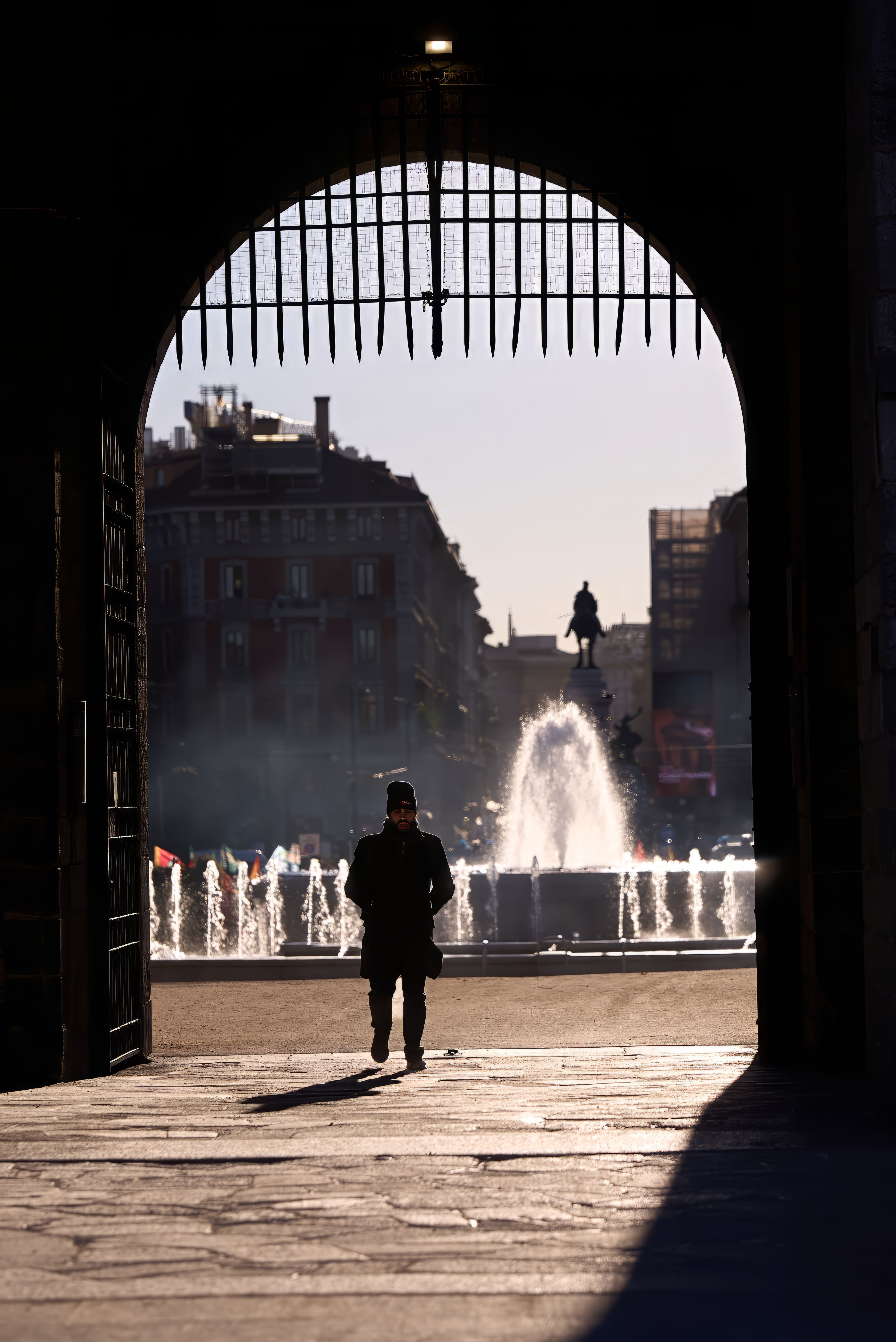 Man Walking through Iron Gate · Free Stock Photo