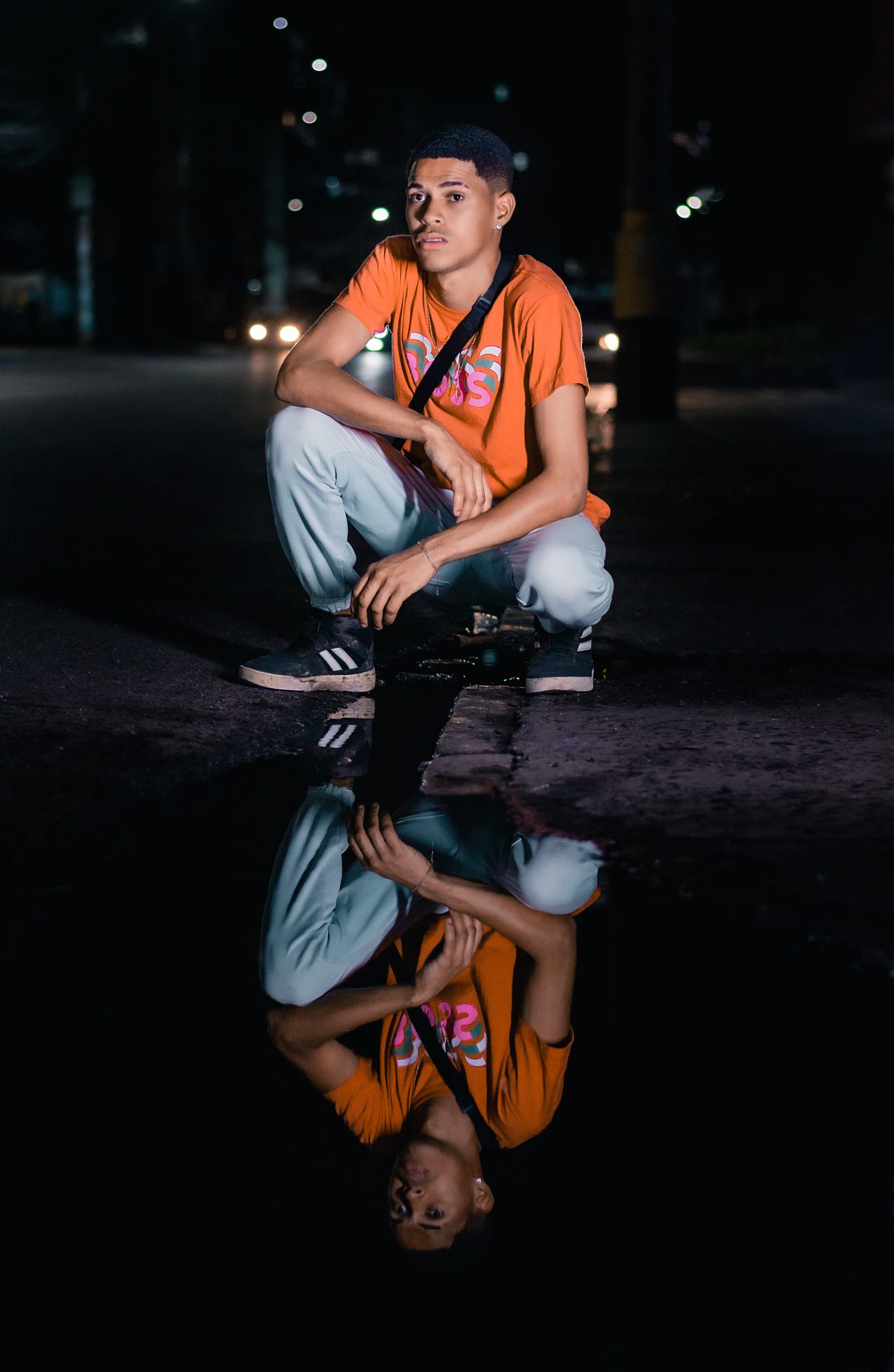 A Teenager Reflecting in a Puddle · Free Stock Photo