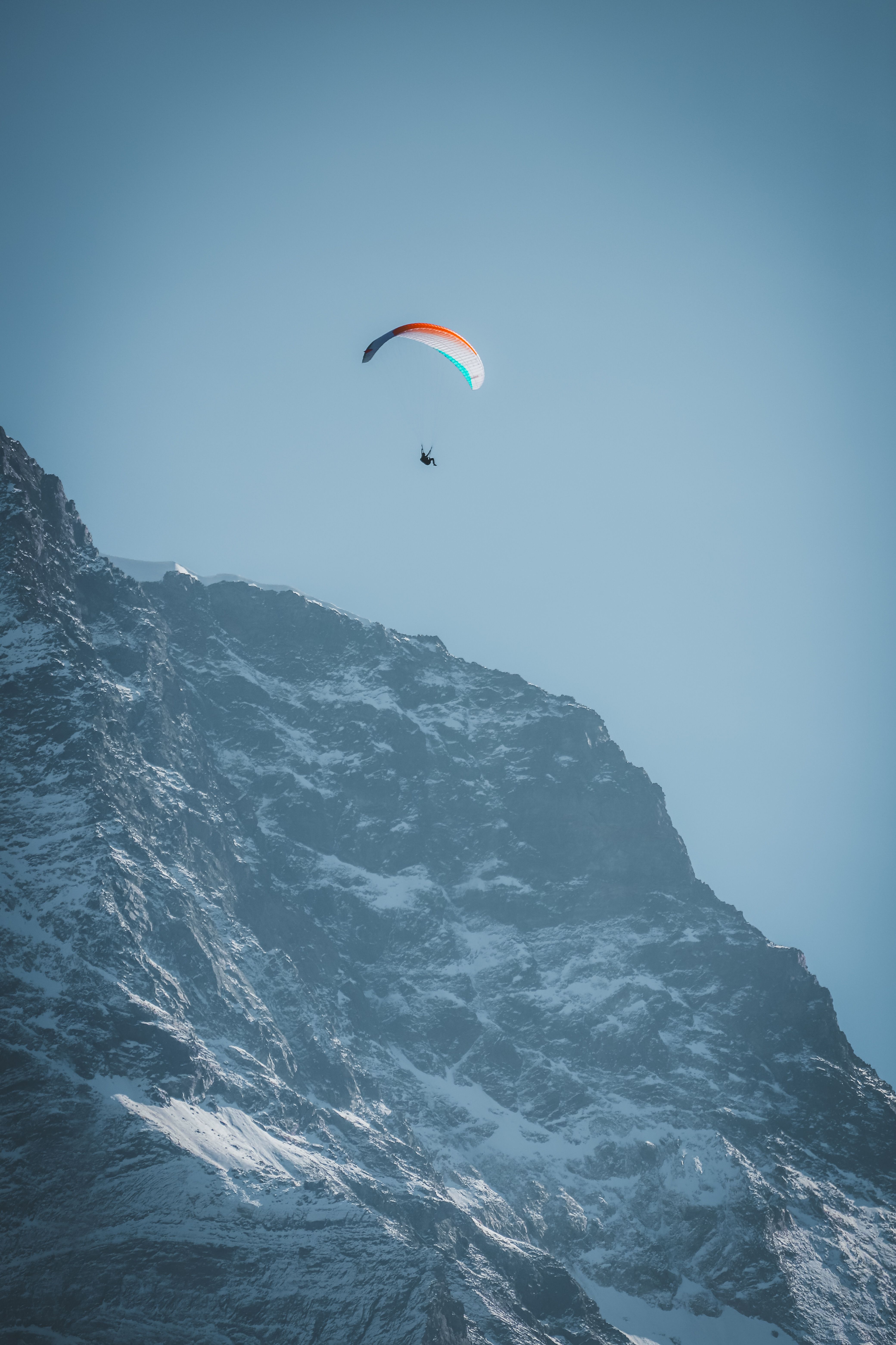 Glide Flying over Snowed Mountains · Free Stock Photo