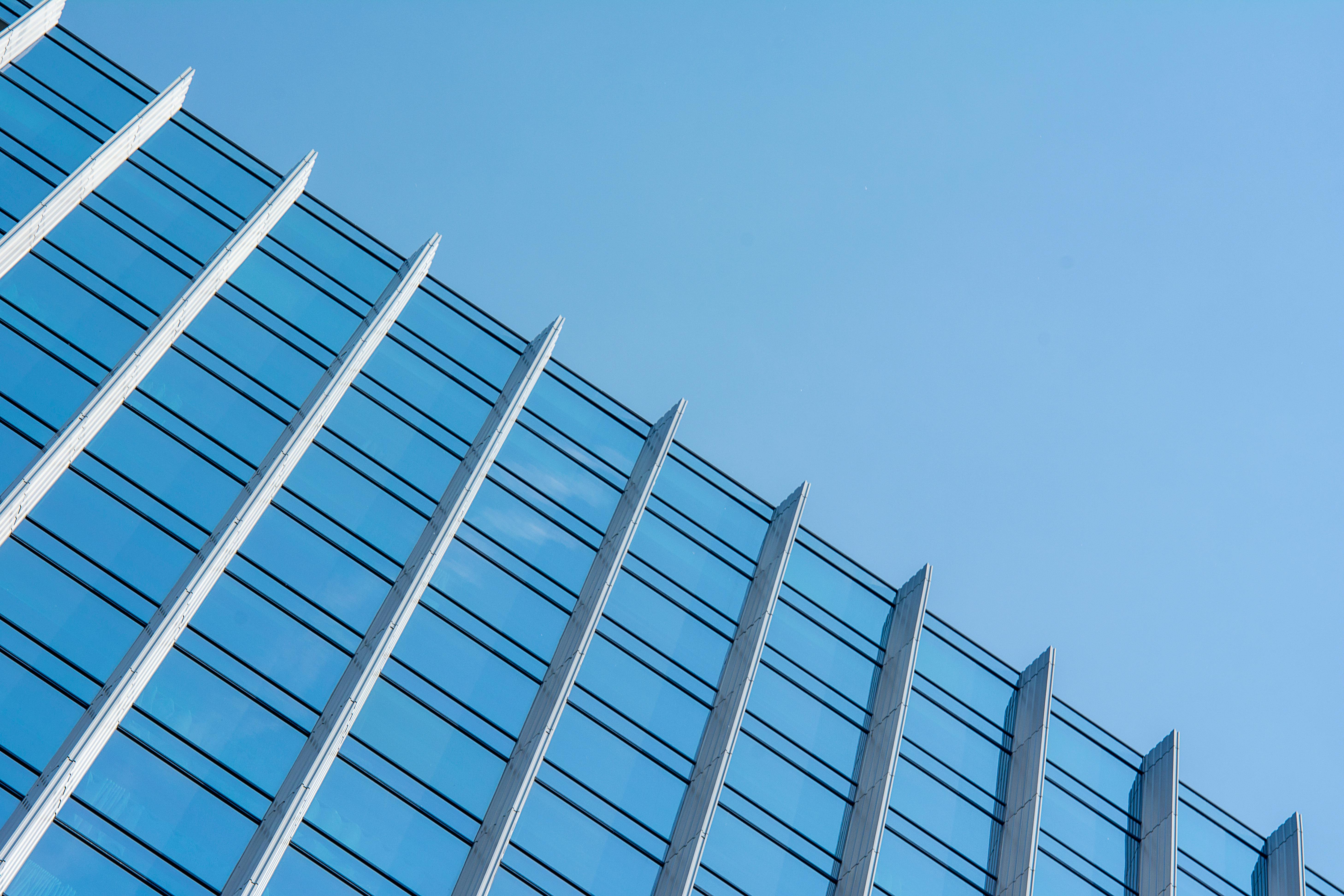 Low Angle Shot of a Modern Building with Glass Facade · Free Stock Photo