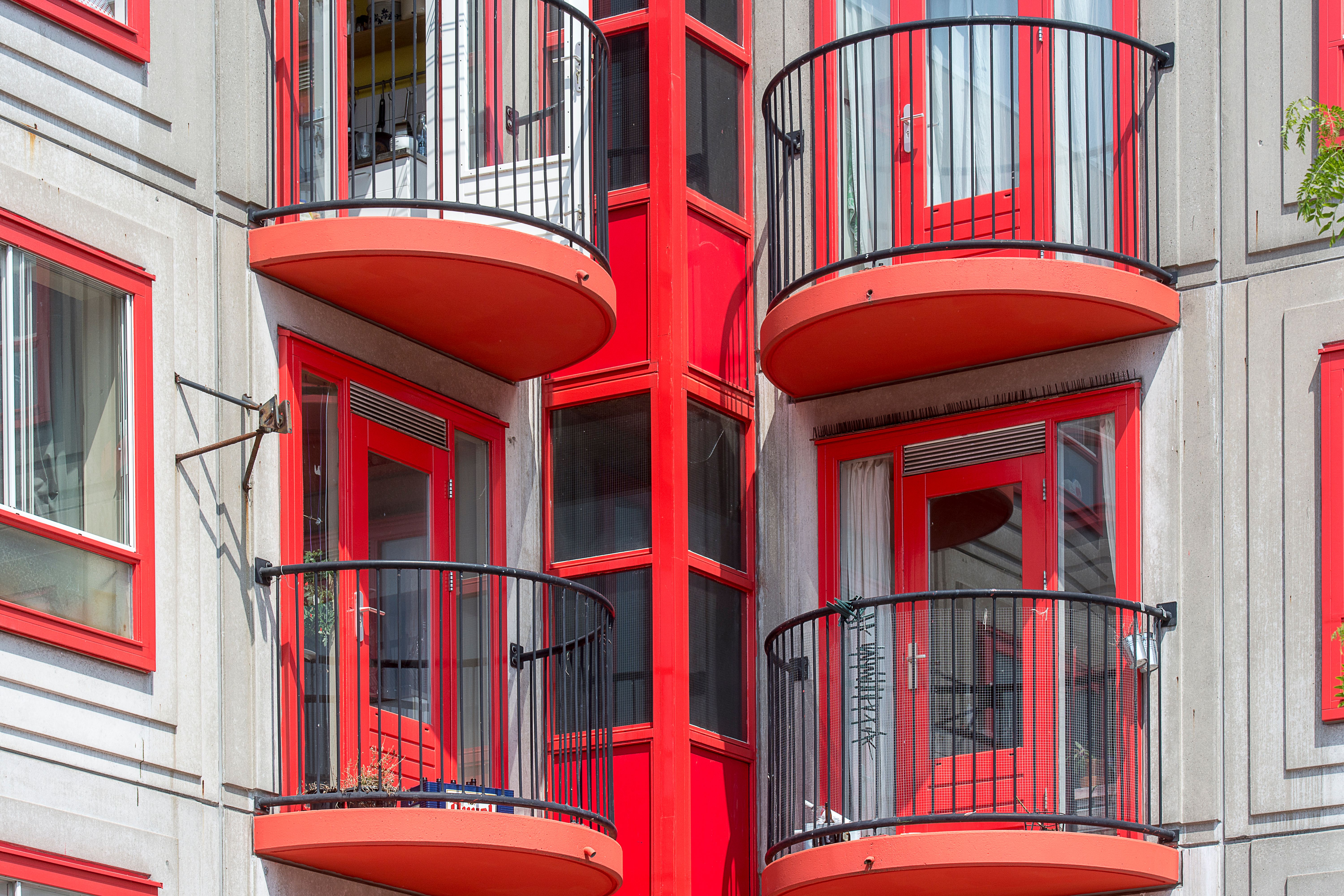 Closeup of a Building with Red Balconies · Free Stock Photo