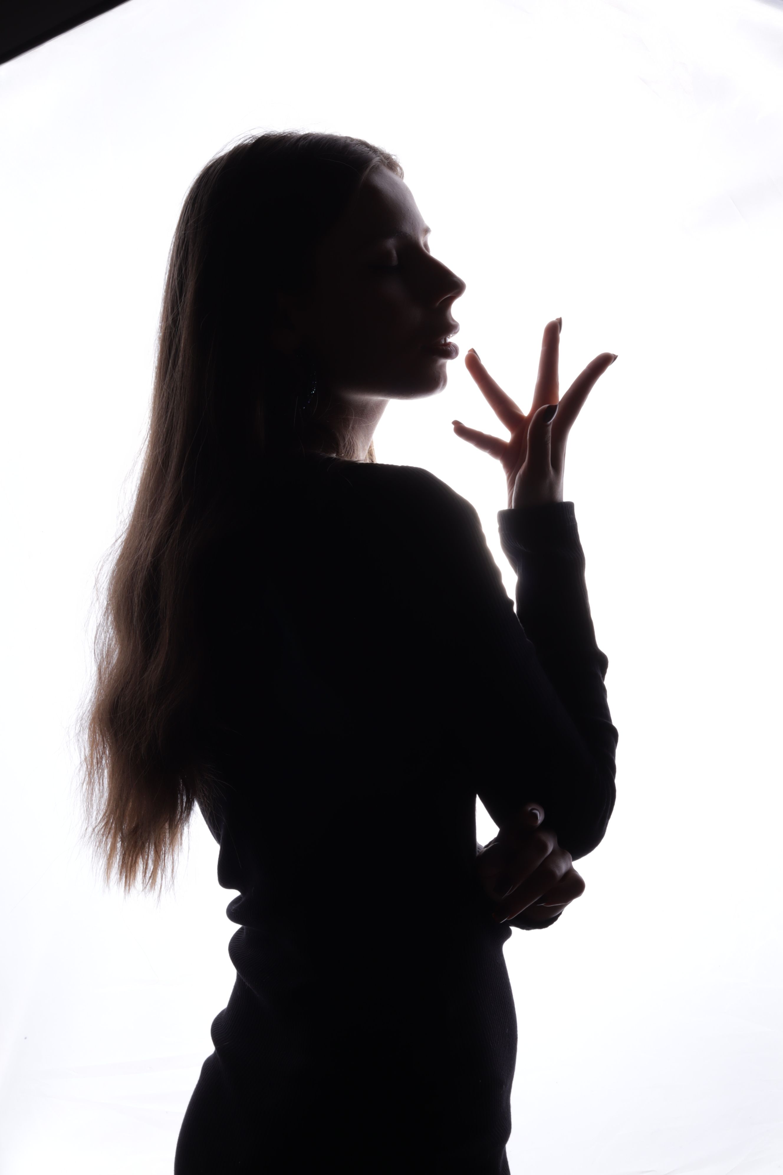 Woman Standing with Hand Raised on White Background · Free Stock Photo