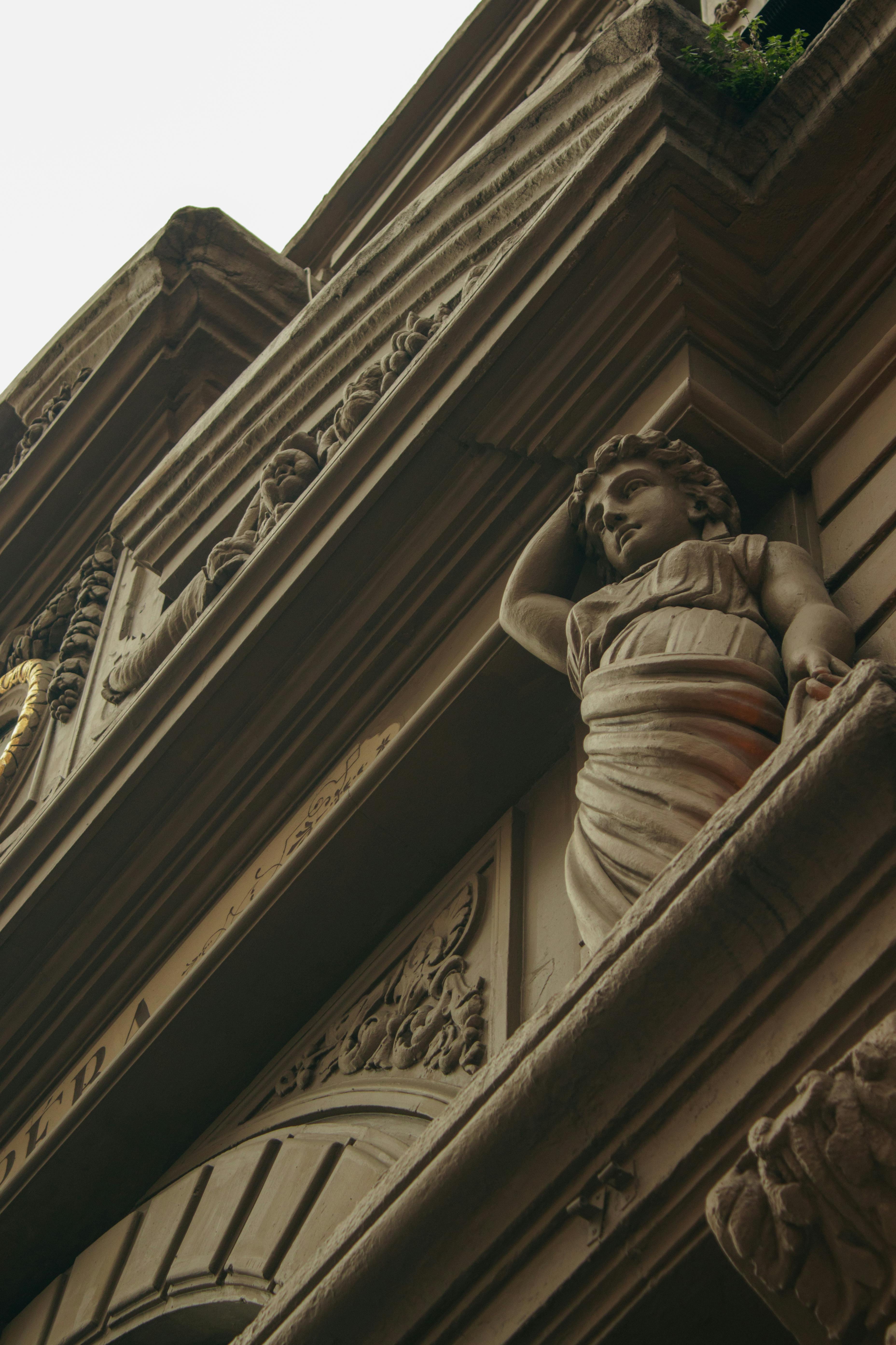 Ornamented Statue on Building Wall · Free Stock Photo