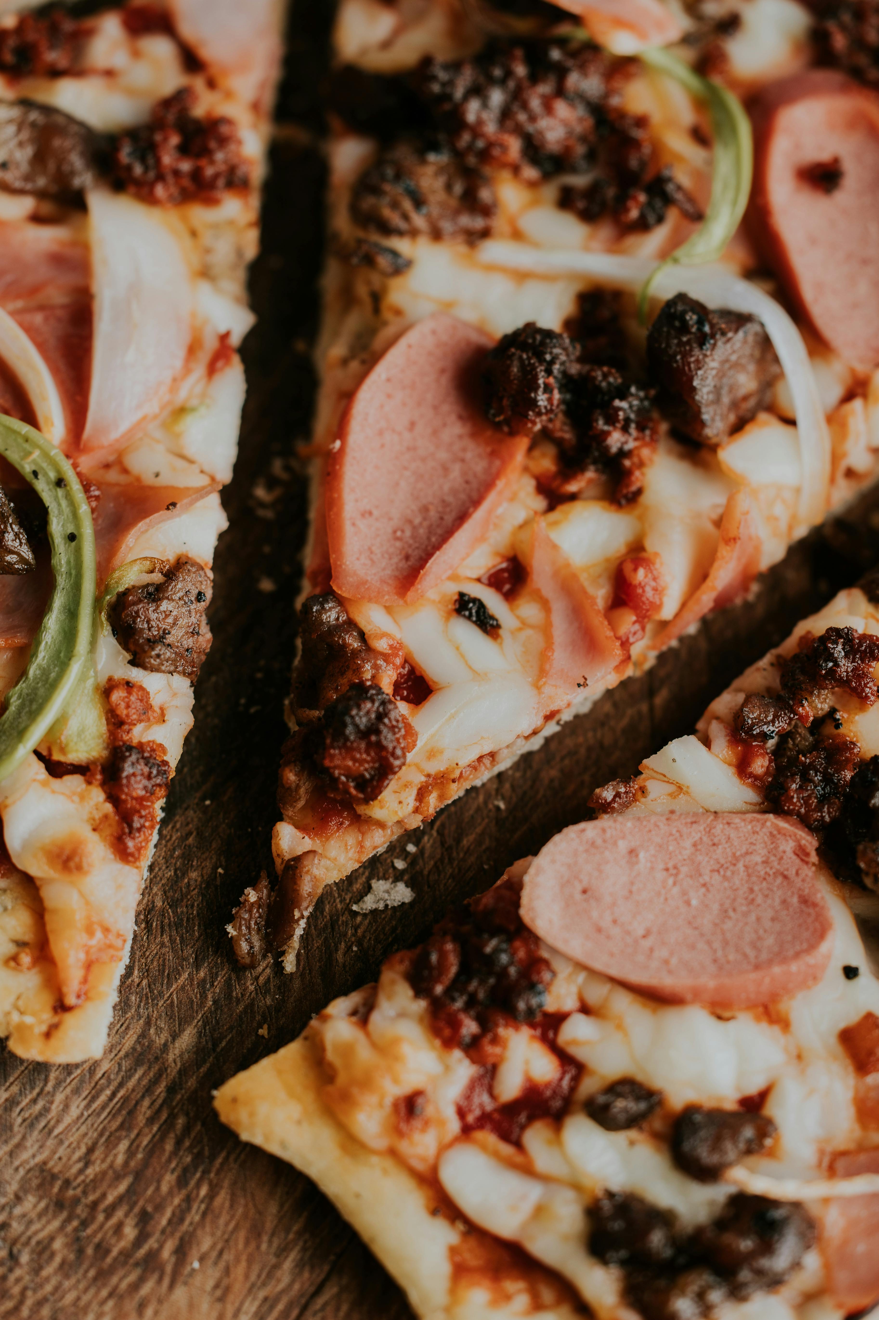 Closeup of Pizza with Hod Dog Sausages and Roasted Meat · Free Stock Photo