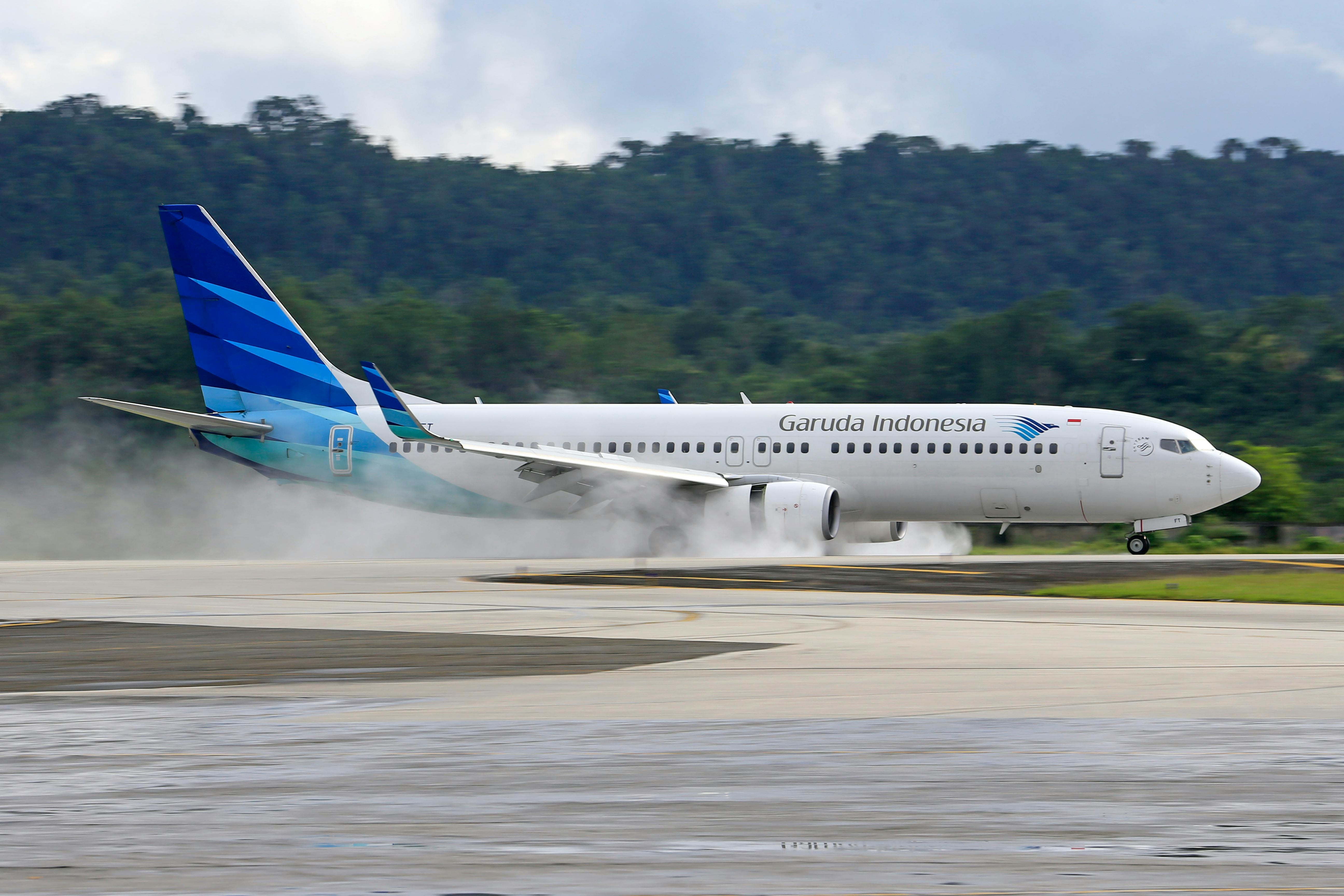 A Garuda Indonesia Airliner Taking Off at an Airport · Free Stock Photo
