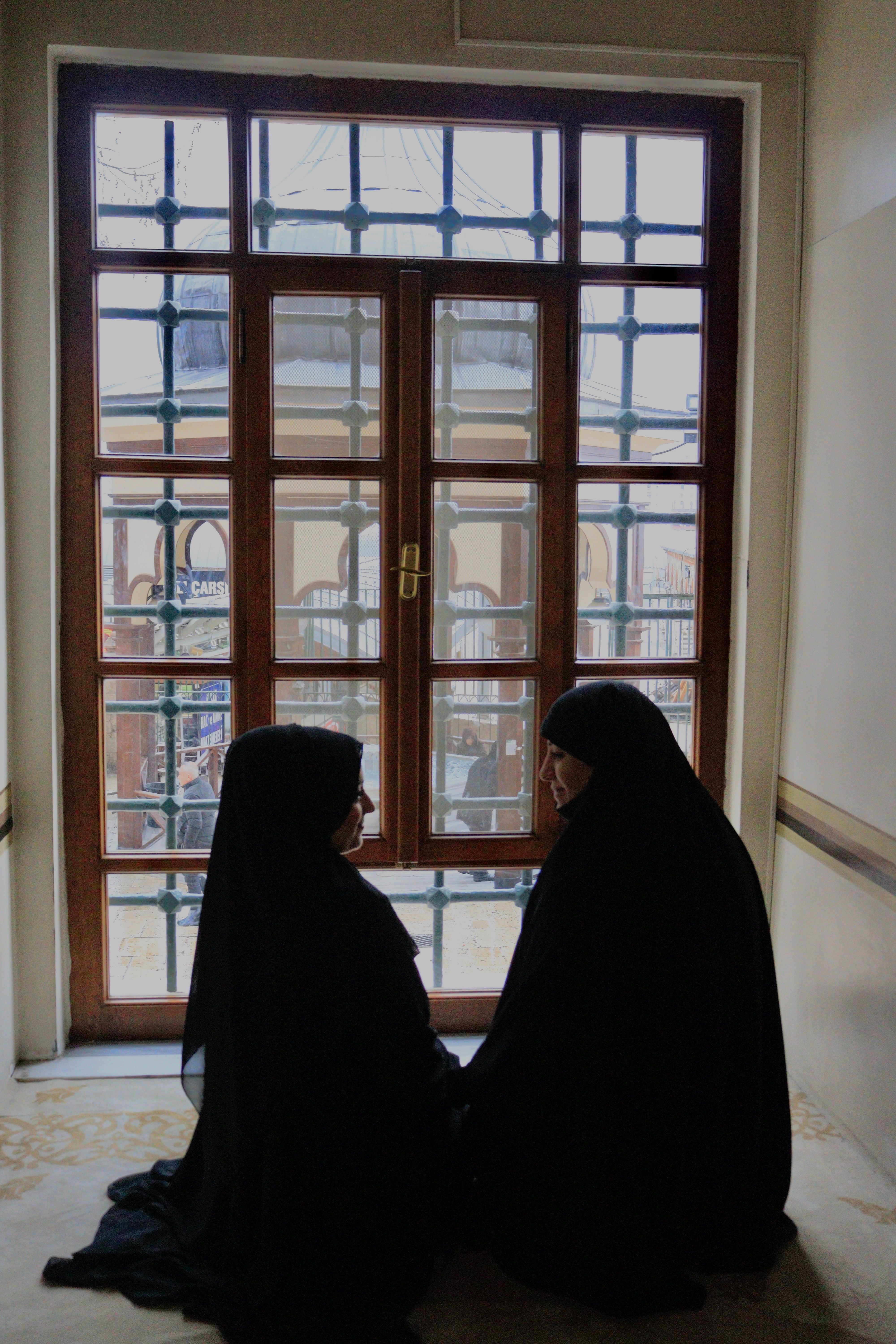 Women in Abayas Sitting at Mosque · Free Stock Photo