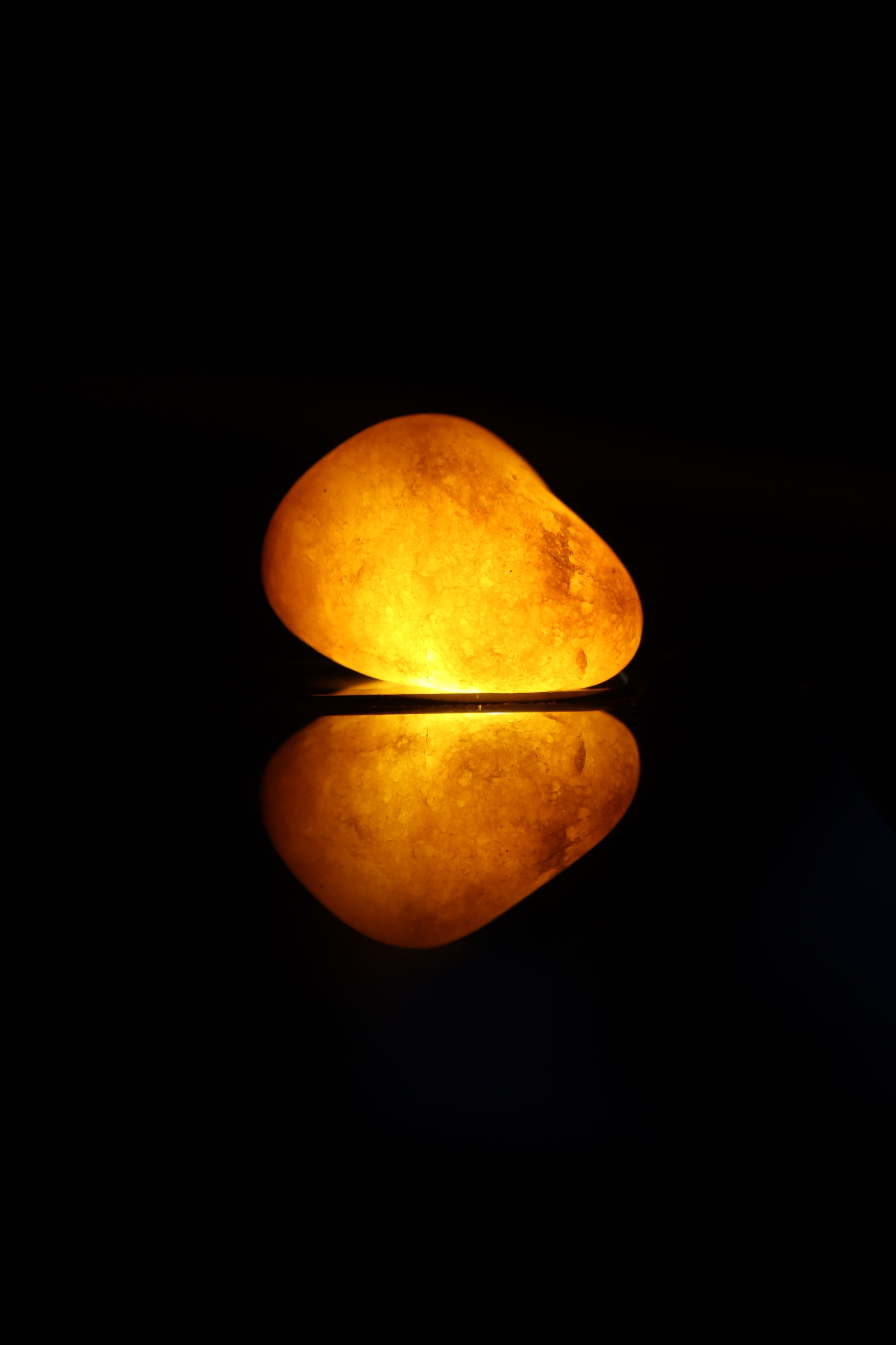 Glowing Stone on a Mirror Surface · Free Stock Photo