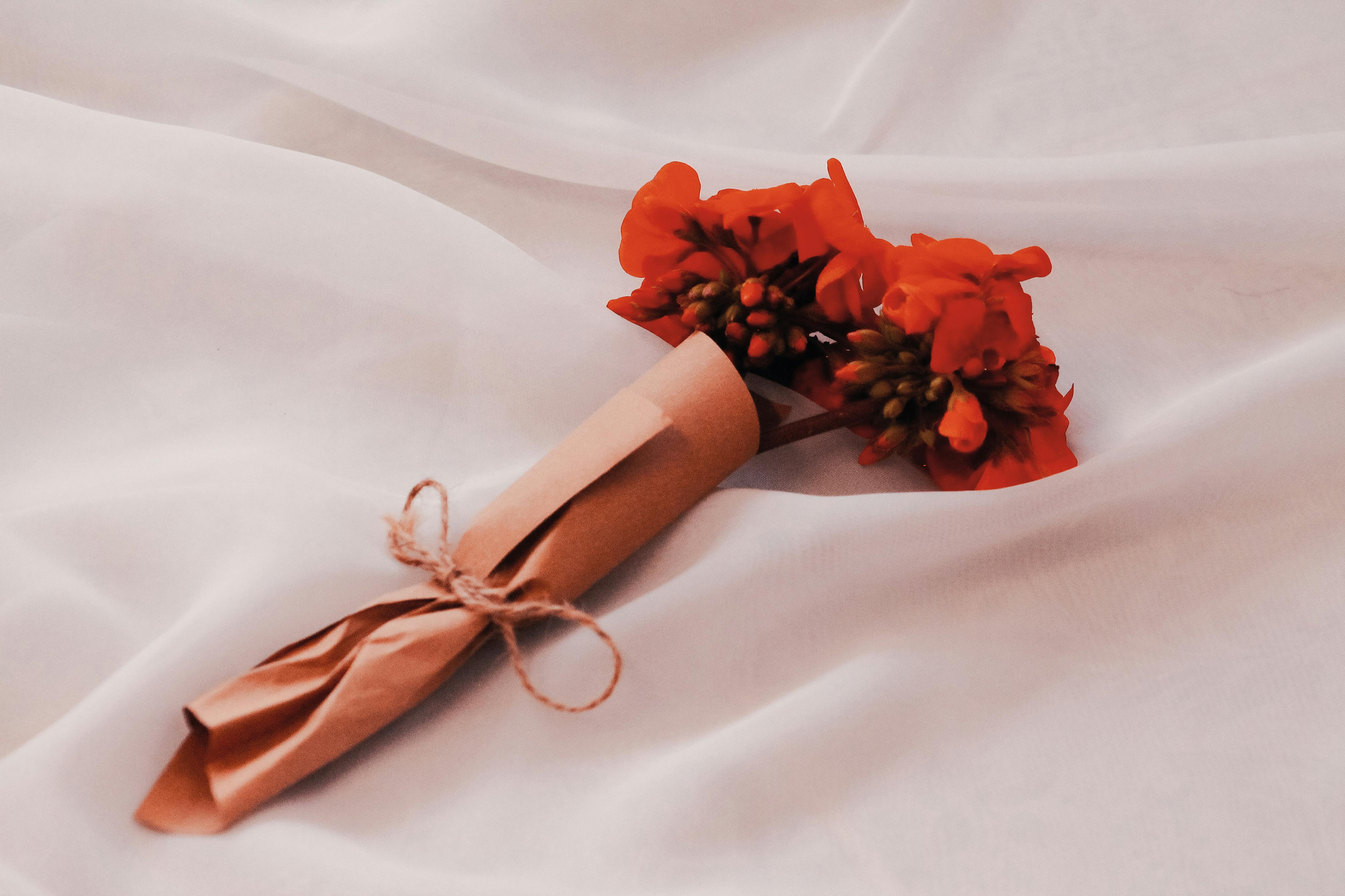 Bouquet of Red Flowers Wrapped in Paper · Free Stock Photo