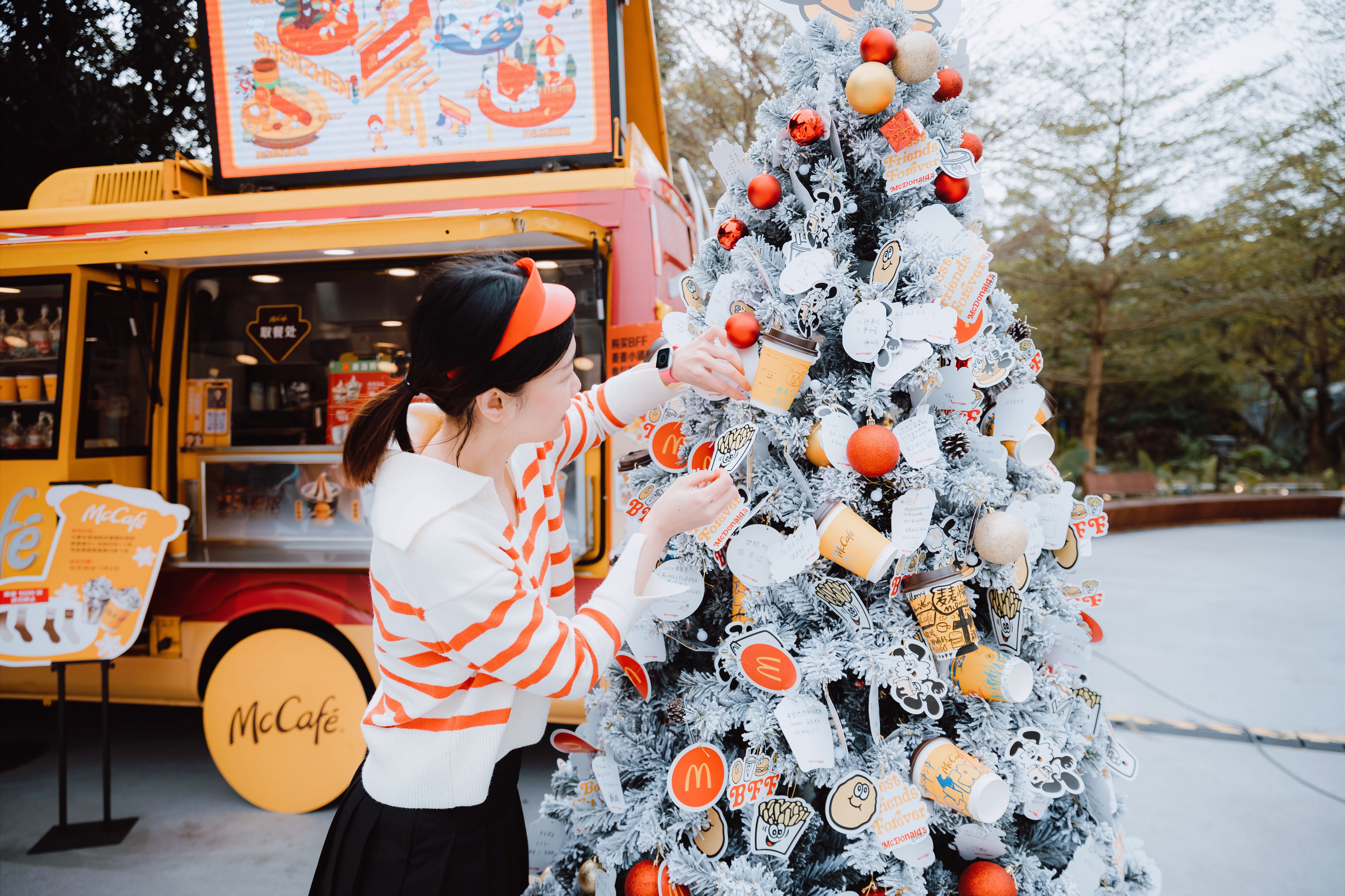Waitress Decorating a Christmas Tree in the Square Next to a McCafe ...