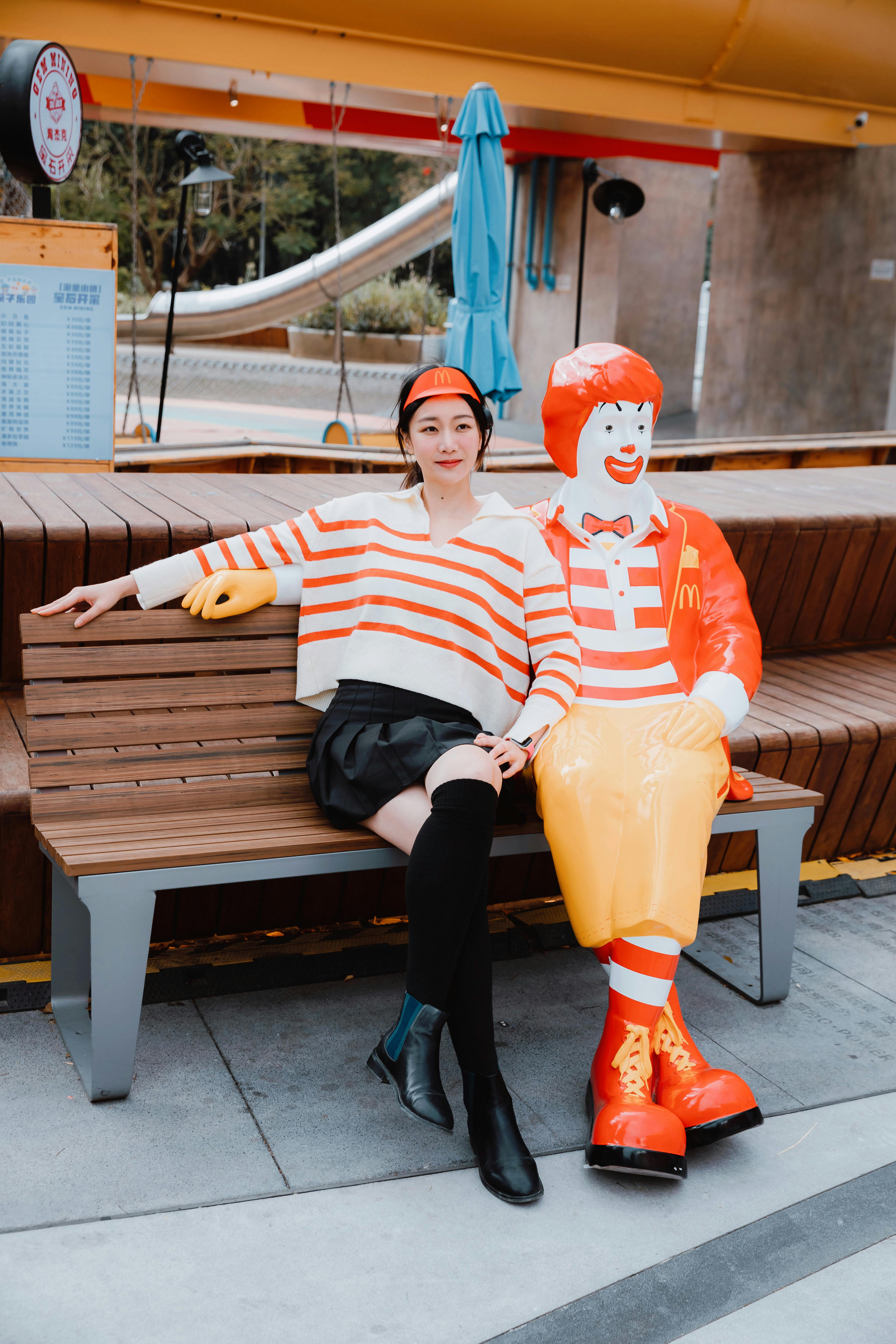 Woman Sitting with Clown on Bench · Free Stock Photo