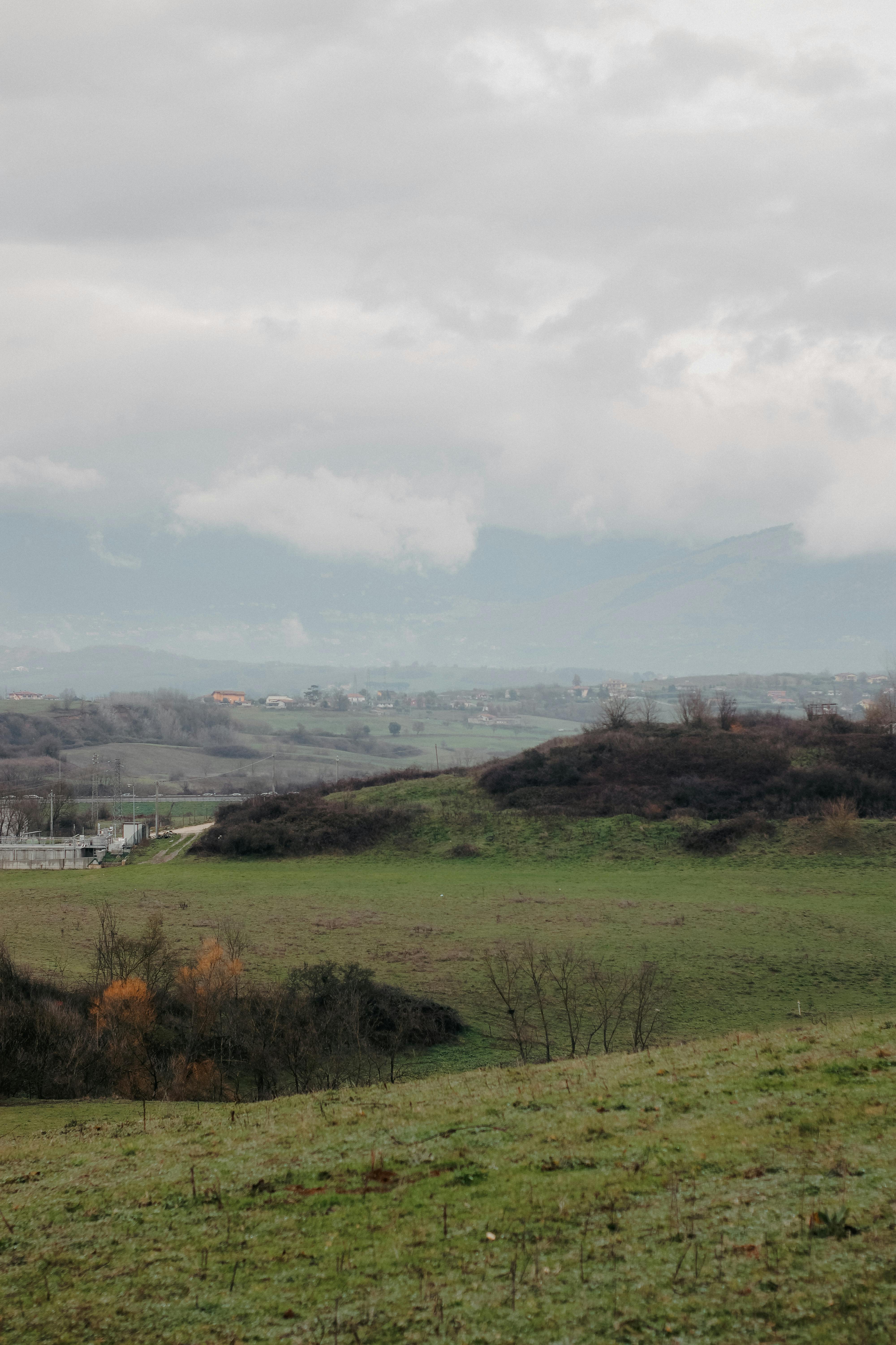 A view of a field with a hill in the distance · Free Stock Photo