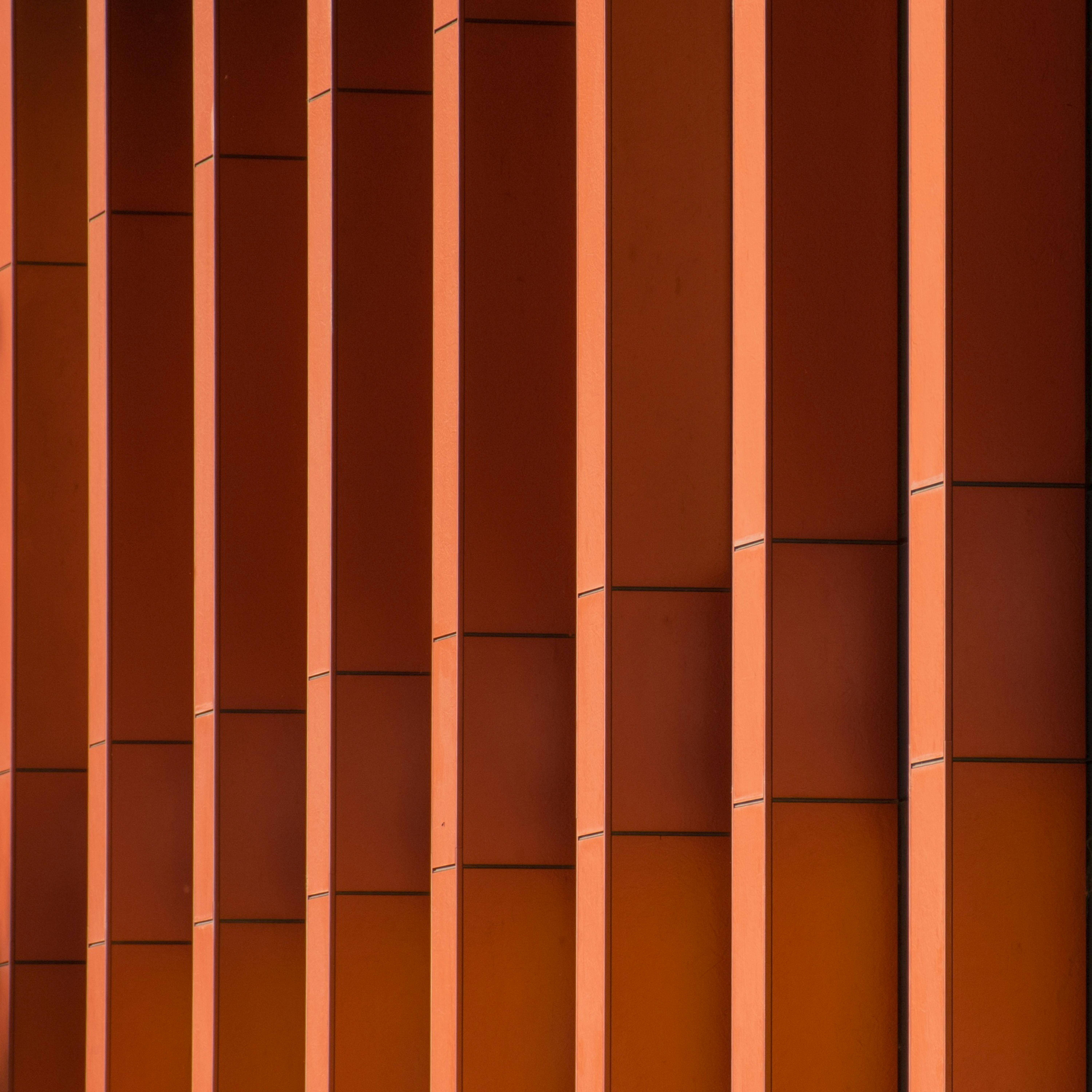 Low Angle Photo of a Red Textured Building Exterior · Free Stock Photo